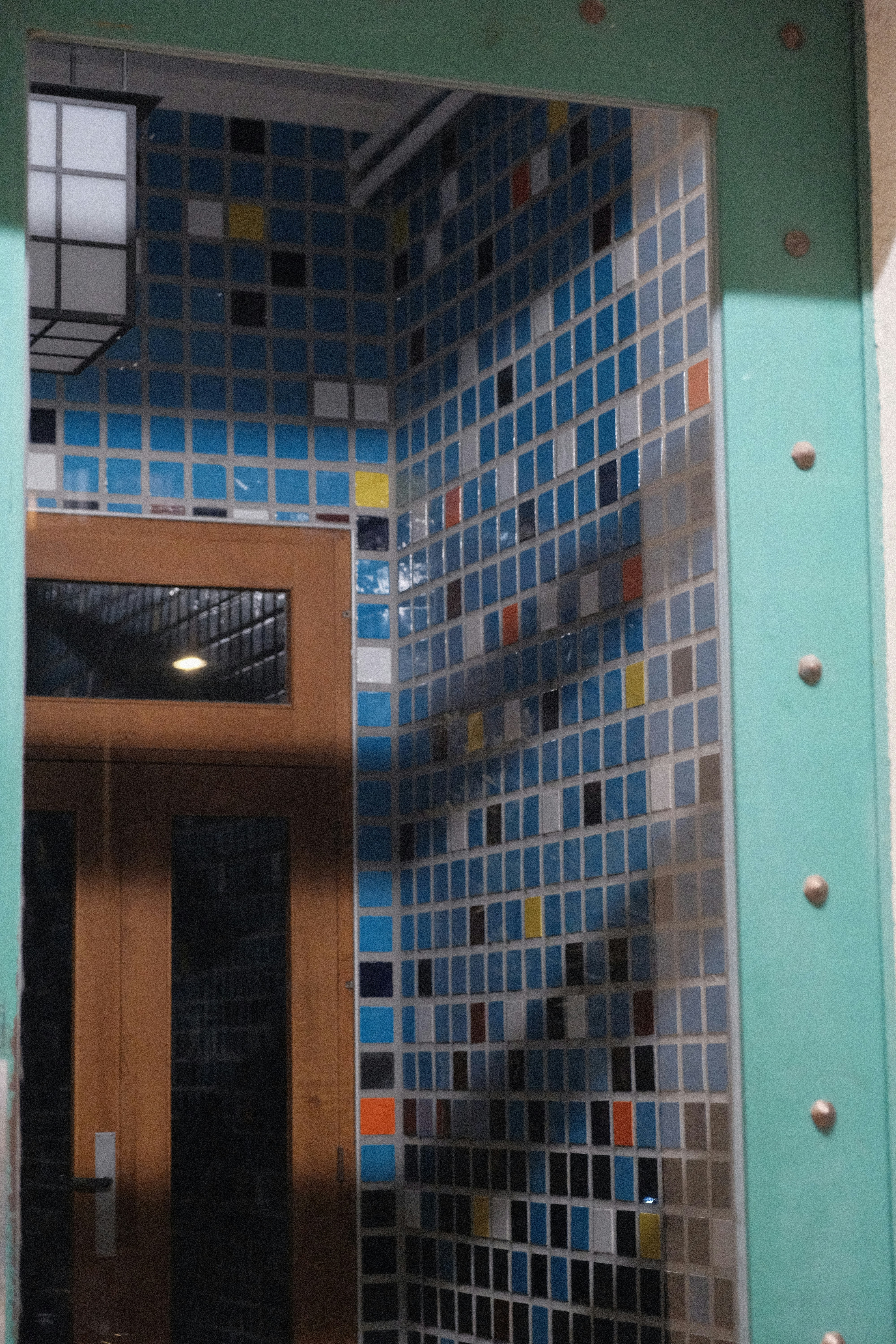 Tile Mosaic Gateway: Neon Mosaic Wall Beside Wooden Door