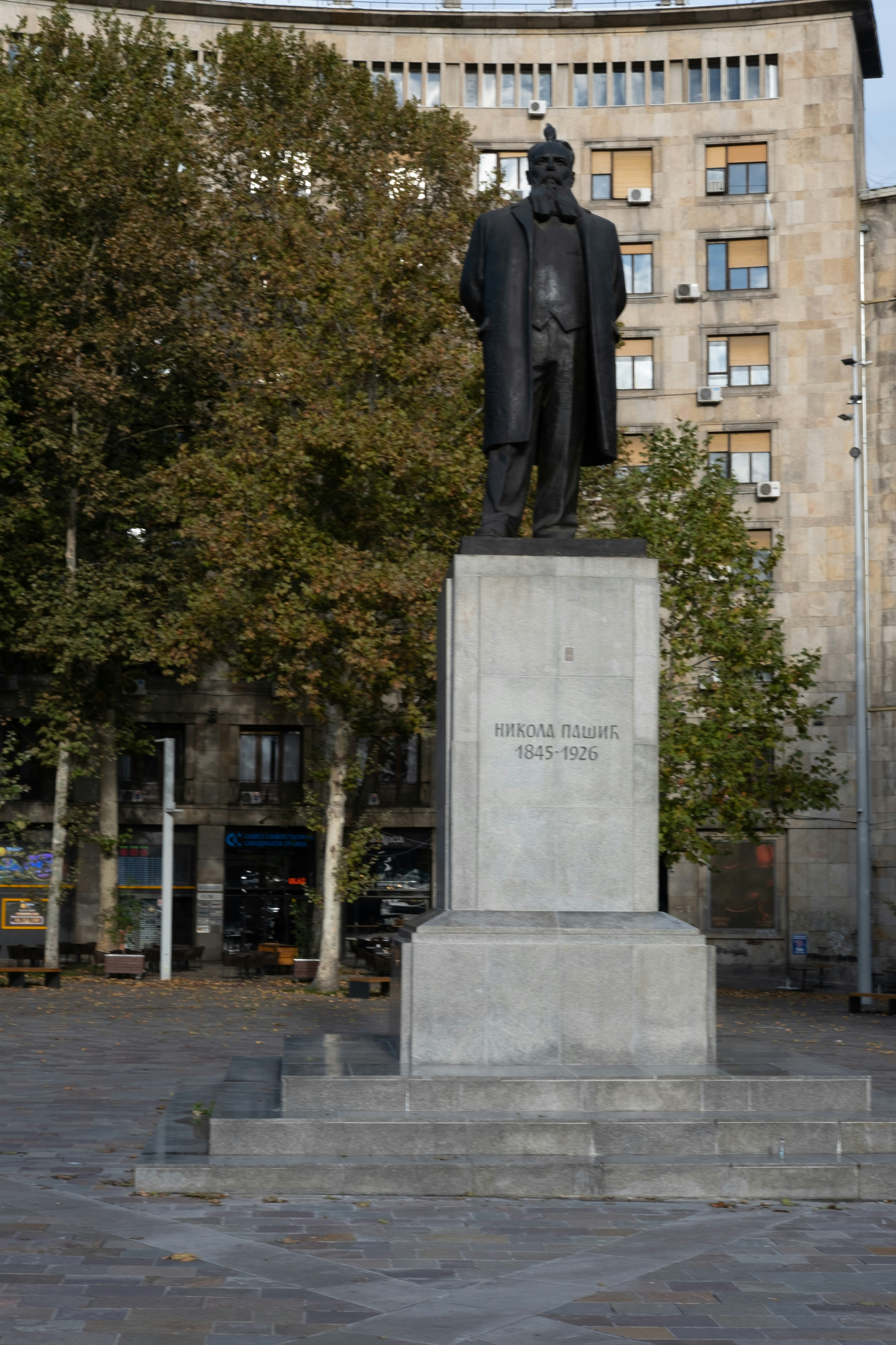 Statue of nikola pašić in front of a building