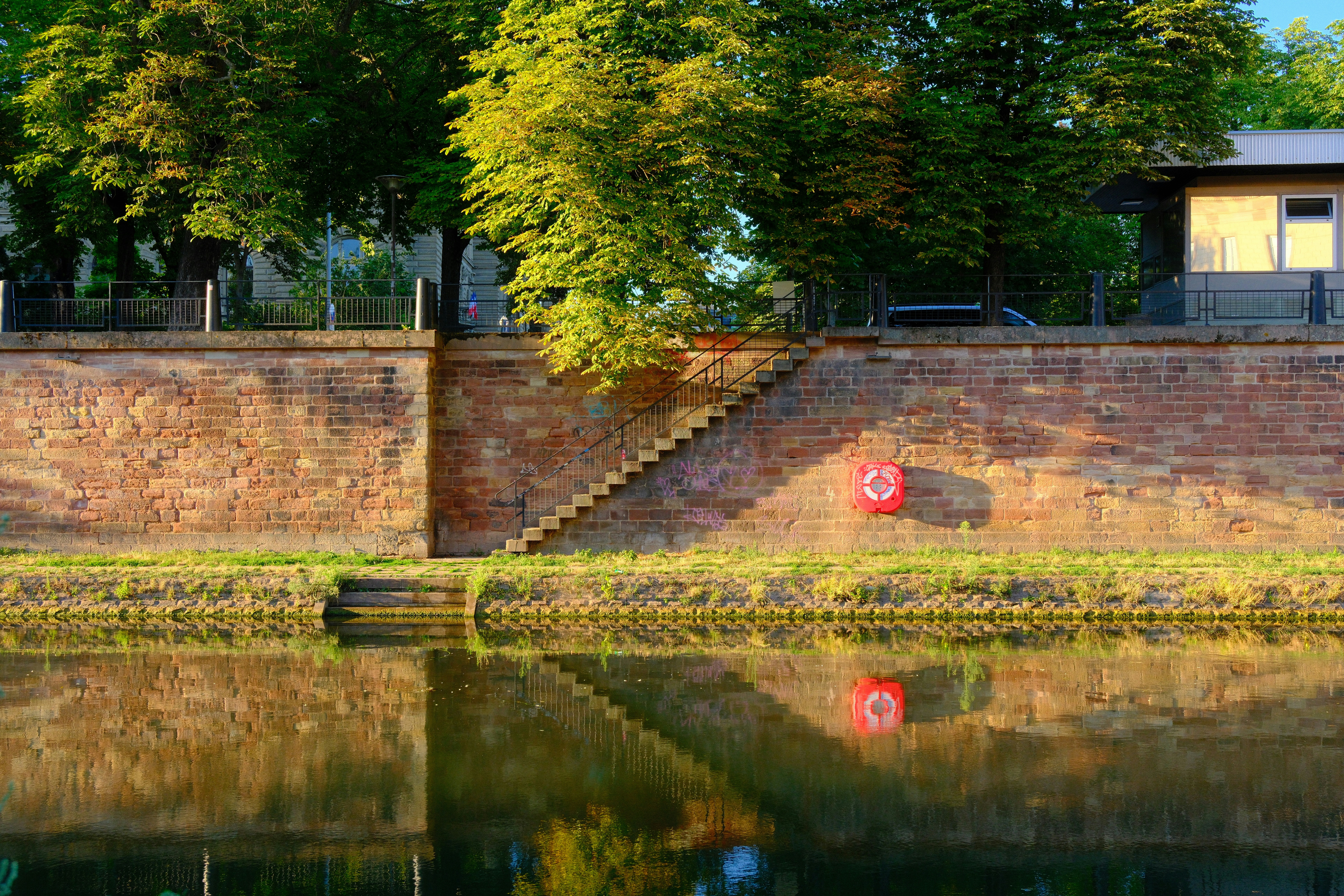 Stone embankment with stairs and reflection in water
