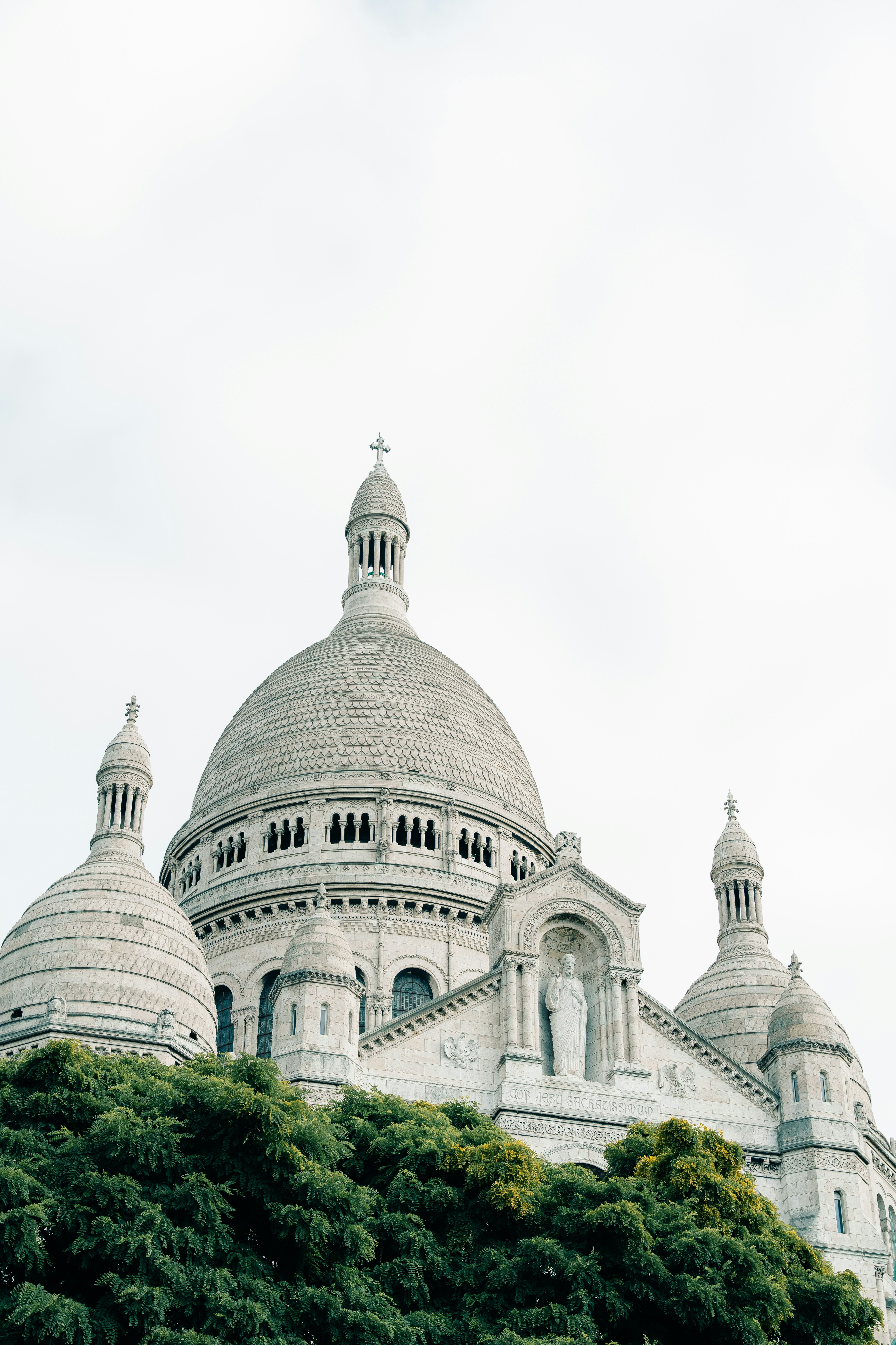 White domed building with green trees below