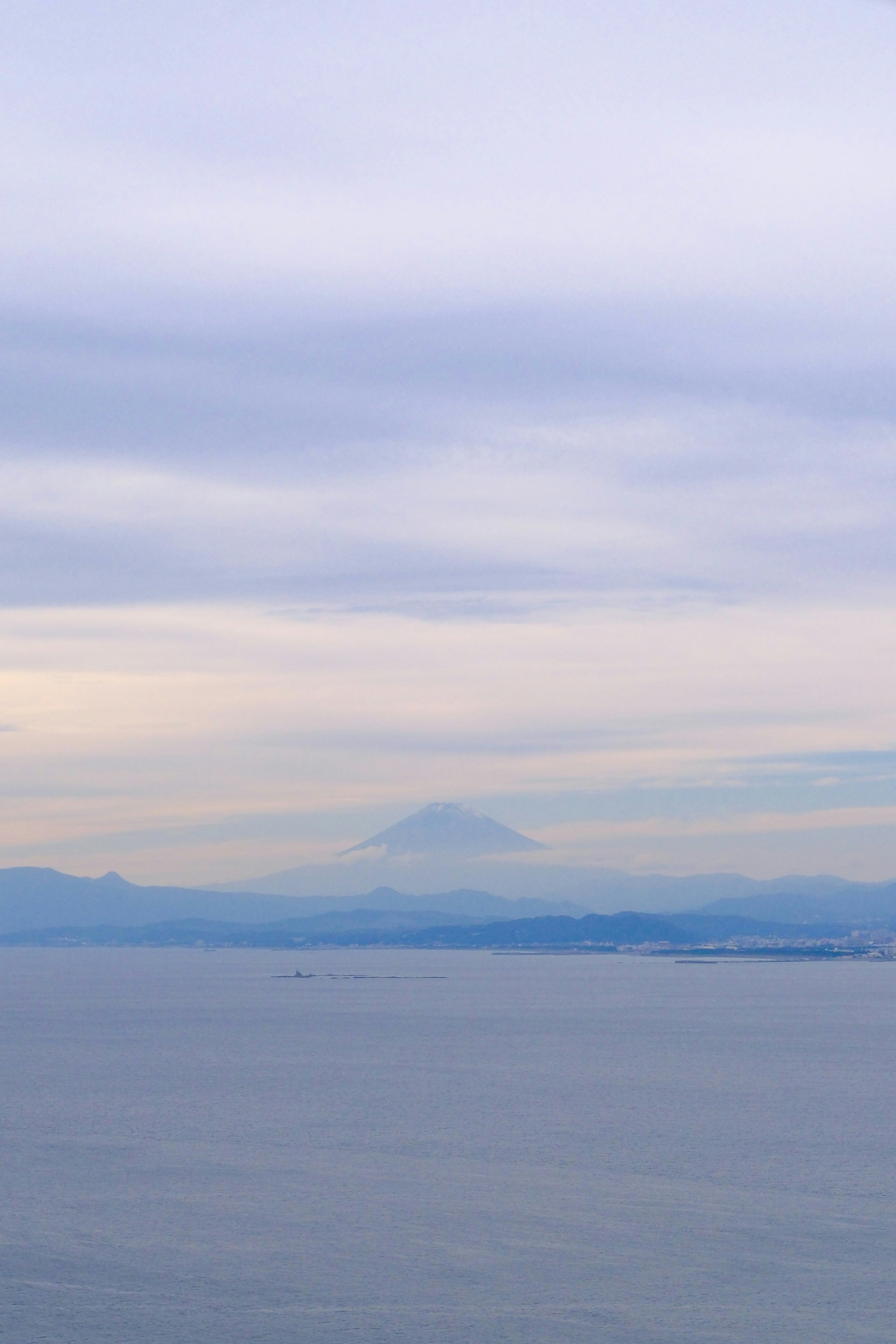 Distant mount fuji visible over the ocean