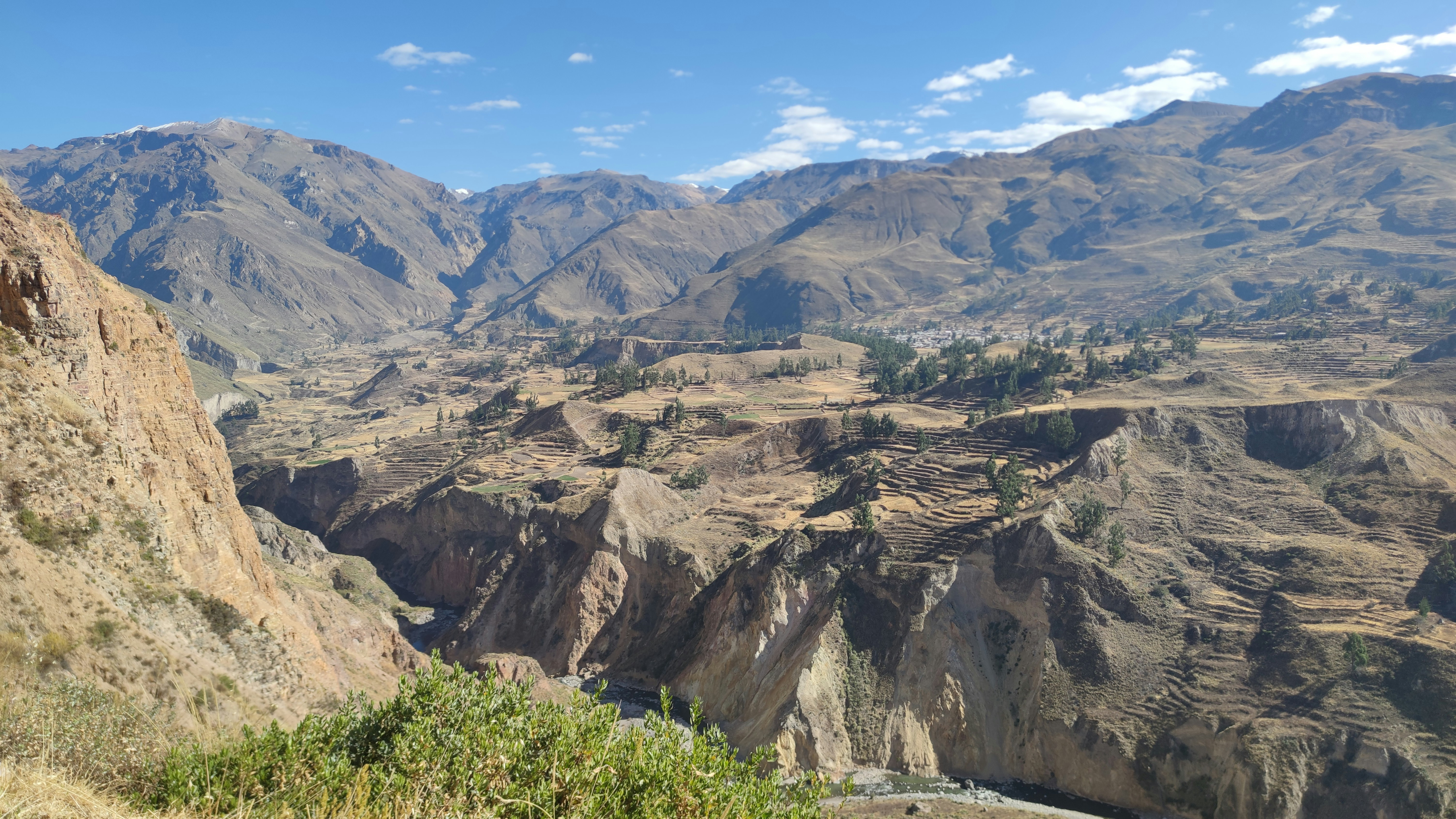 Colca Canyon, Perù ~ 15 August 2025 | Arid mountain valley with steep, eroded slopes under blue sky.