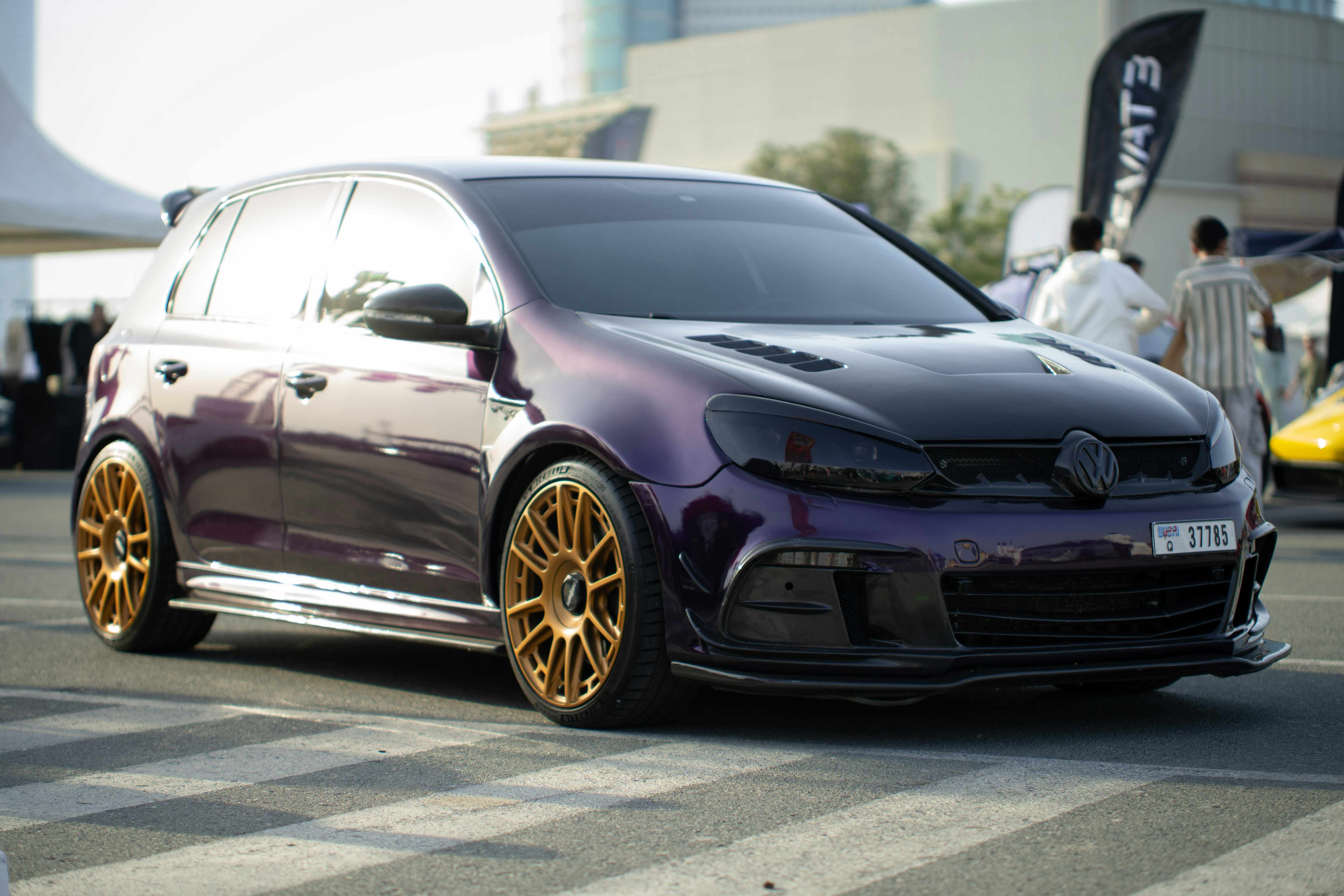 Purple volkswagen golf with gold rims