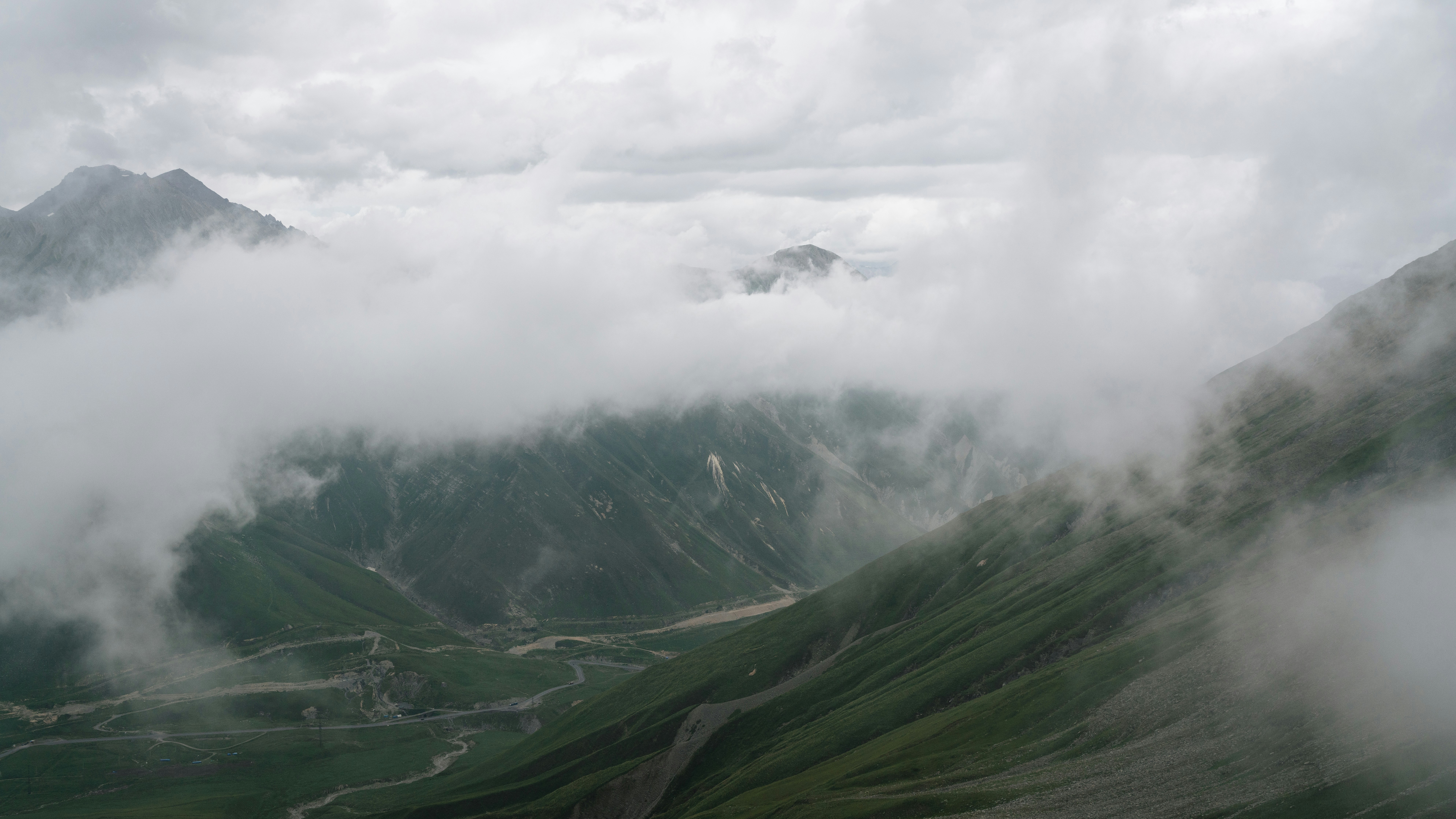 Veil of Mist Over Rolling Green Valleys