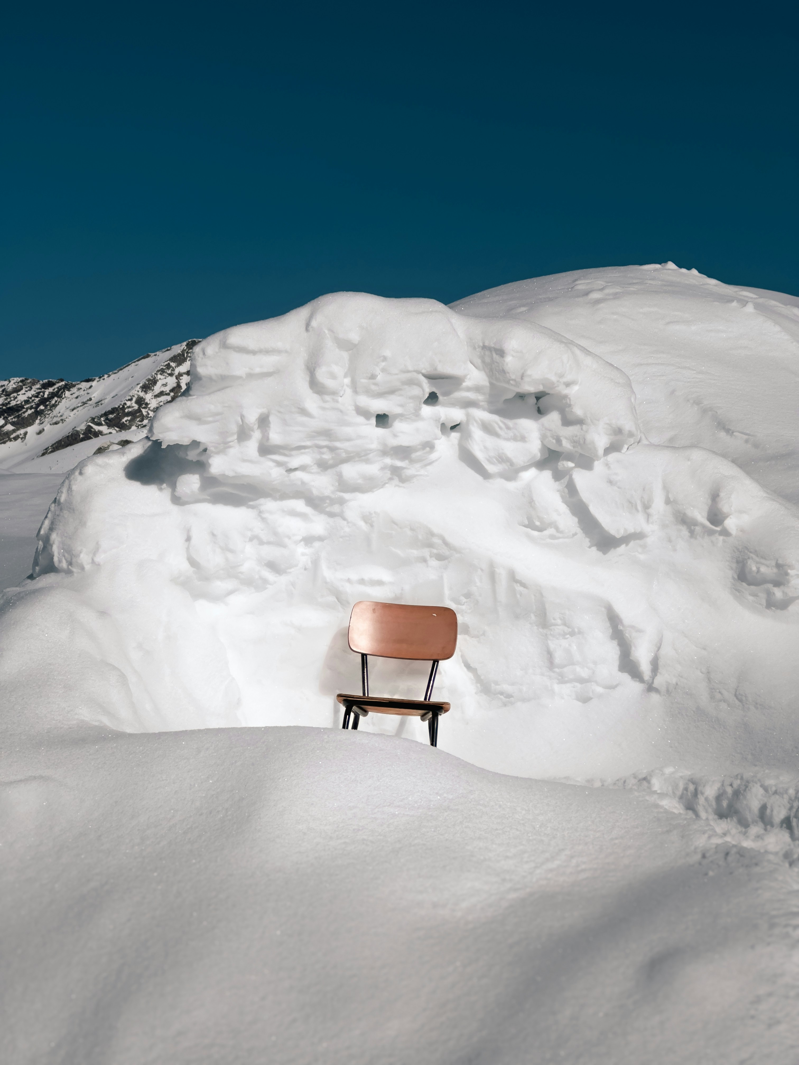 Solitary Chair Amidst the Snowy Expanse