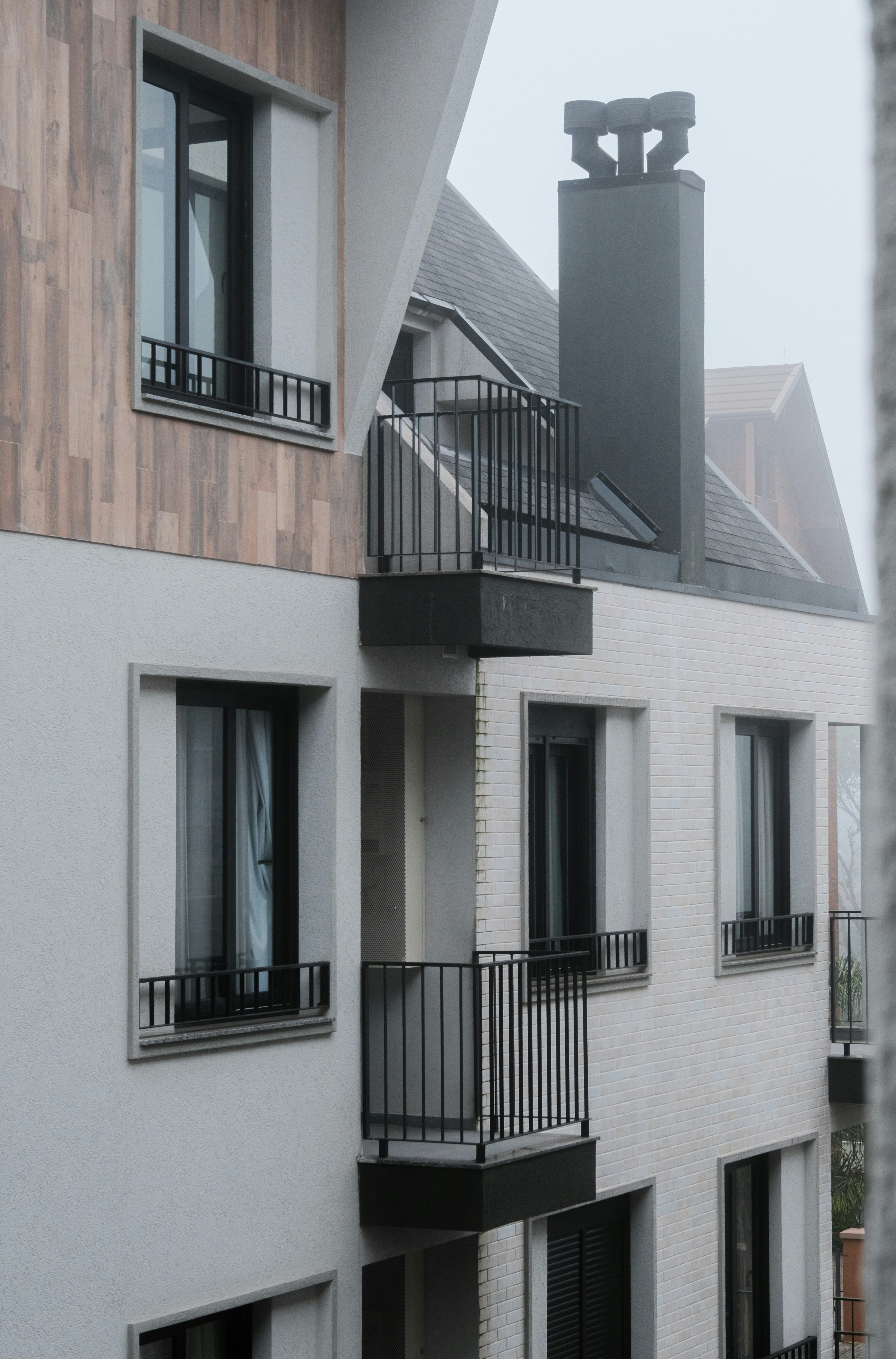 Modern building facade with balconies and windows.