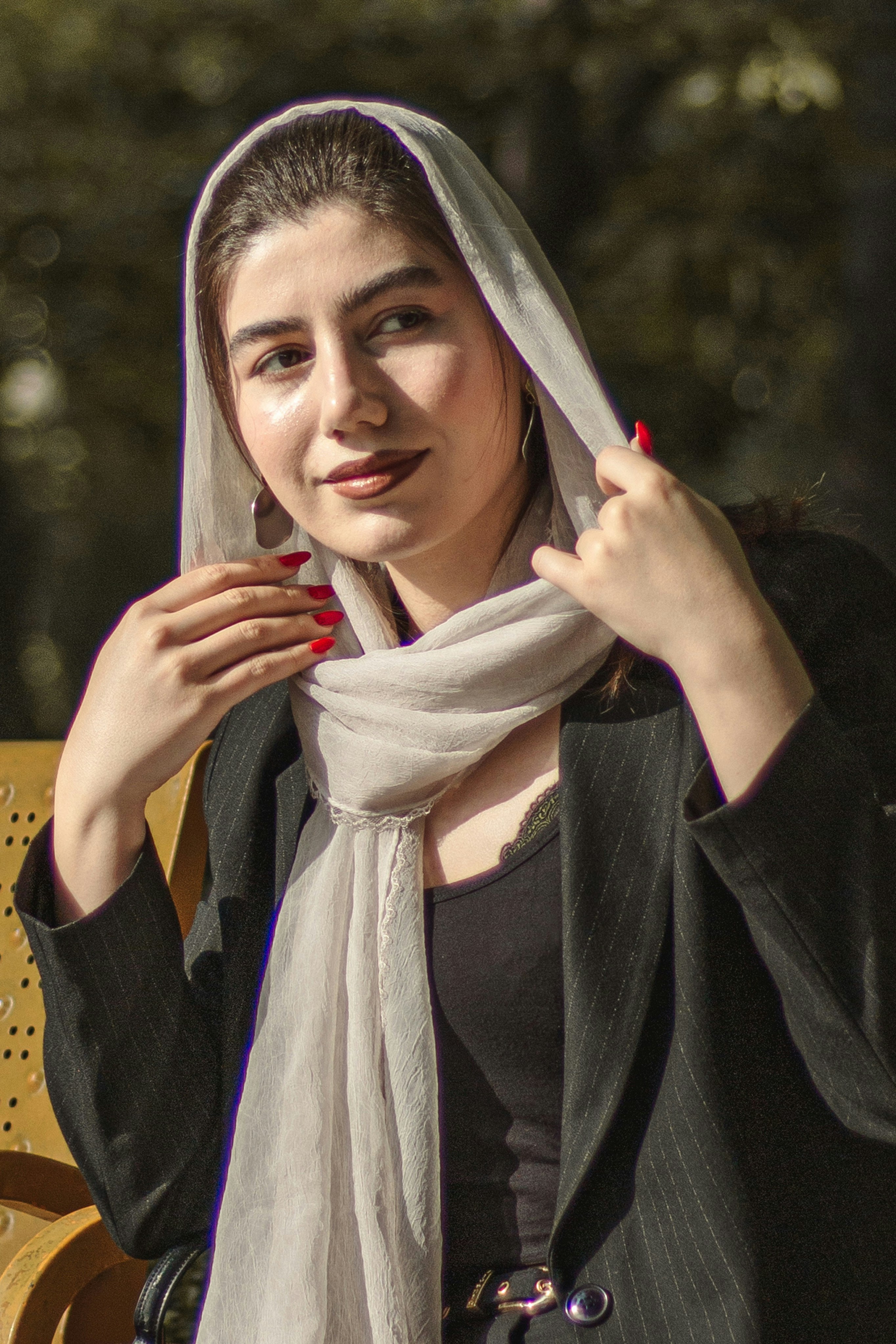 A moment of elegance captured in natural light." | Young woman wearing a headscarf and blazer outdoors