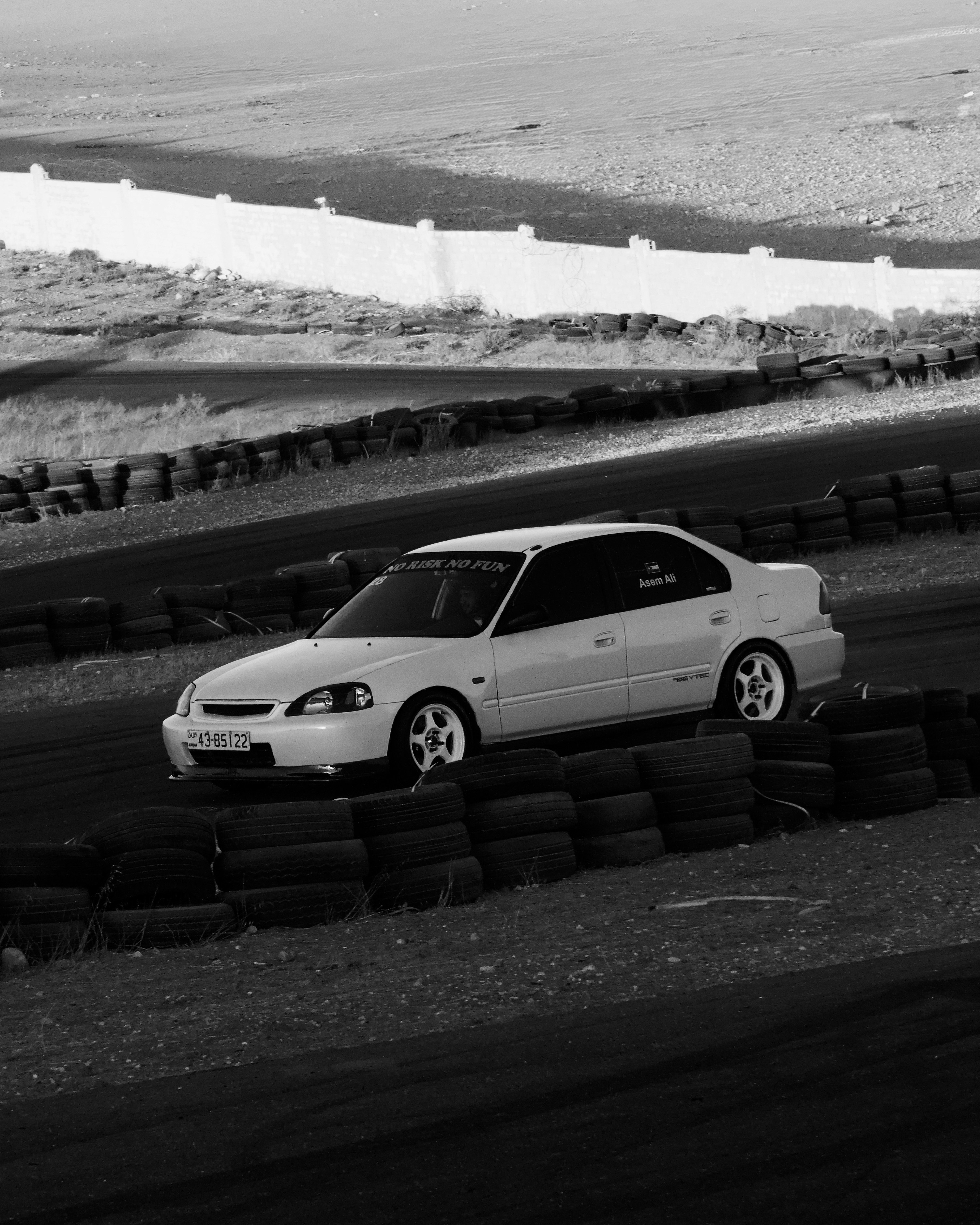 White sedan parked on a race track
