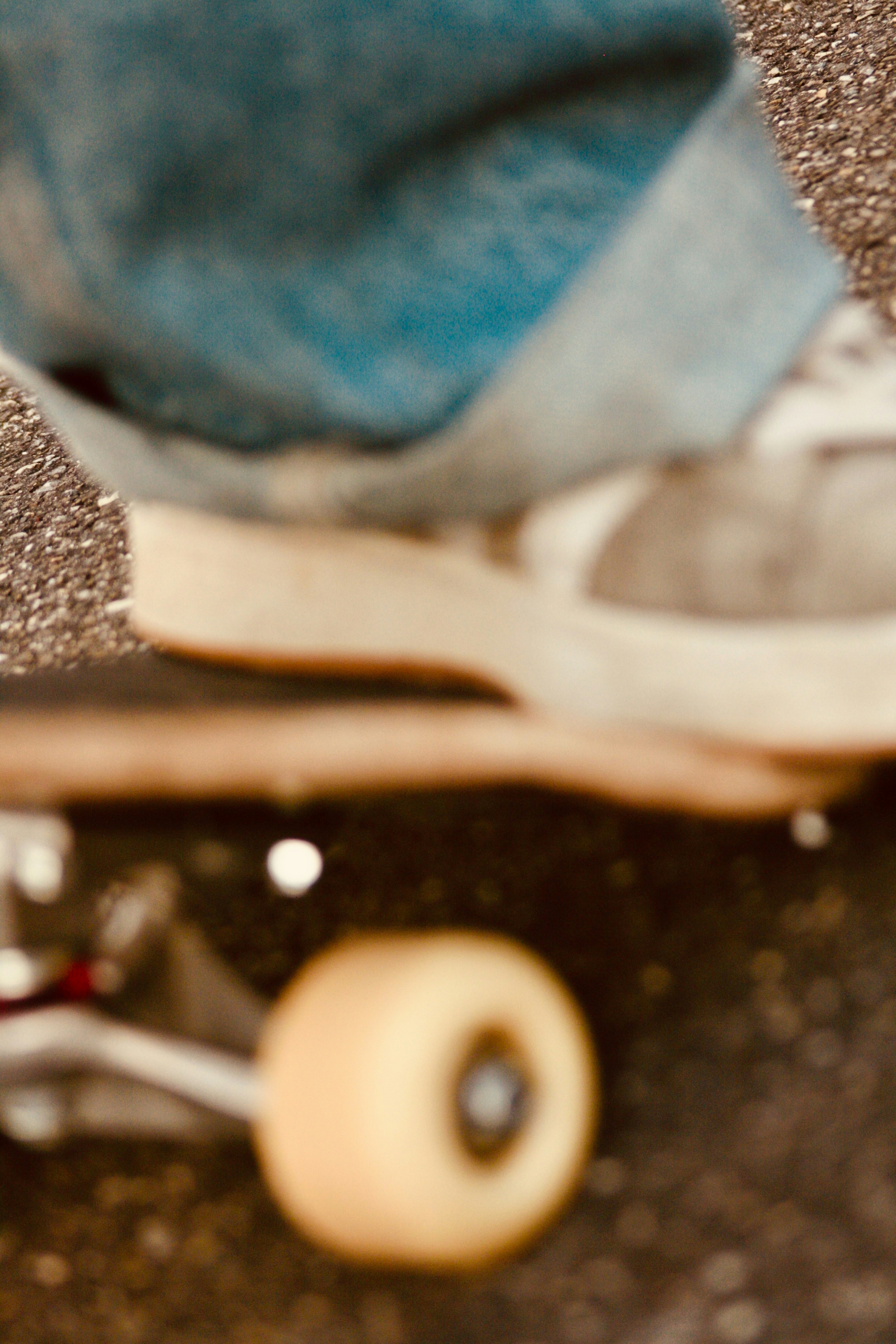 Close-up of a skateboard wheel and foot in motion, highlighting the dynamic energy of skating.
