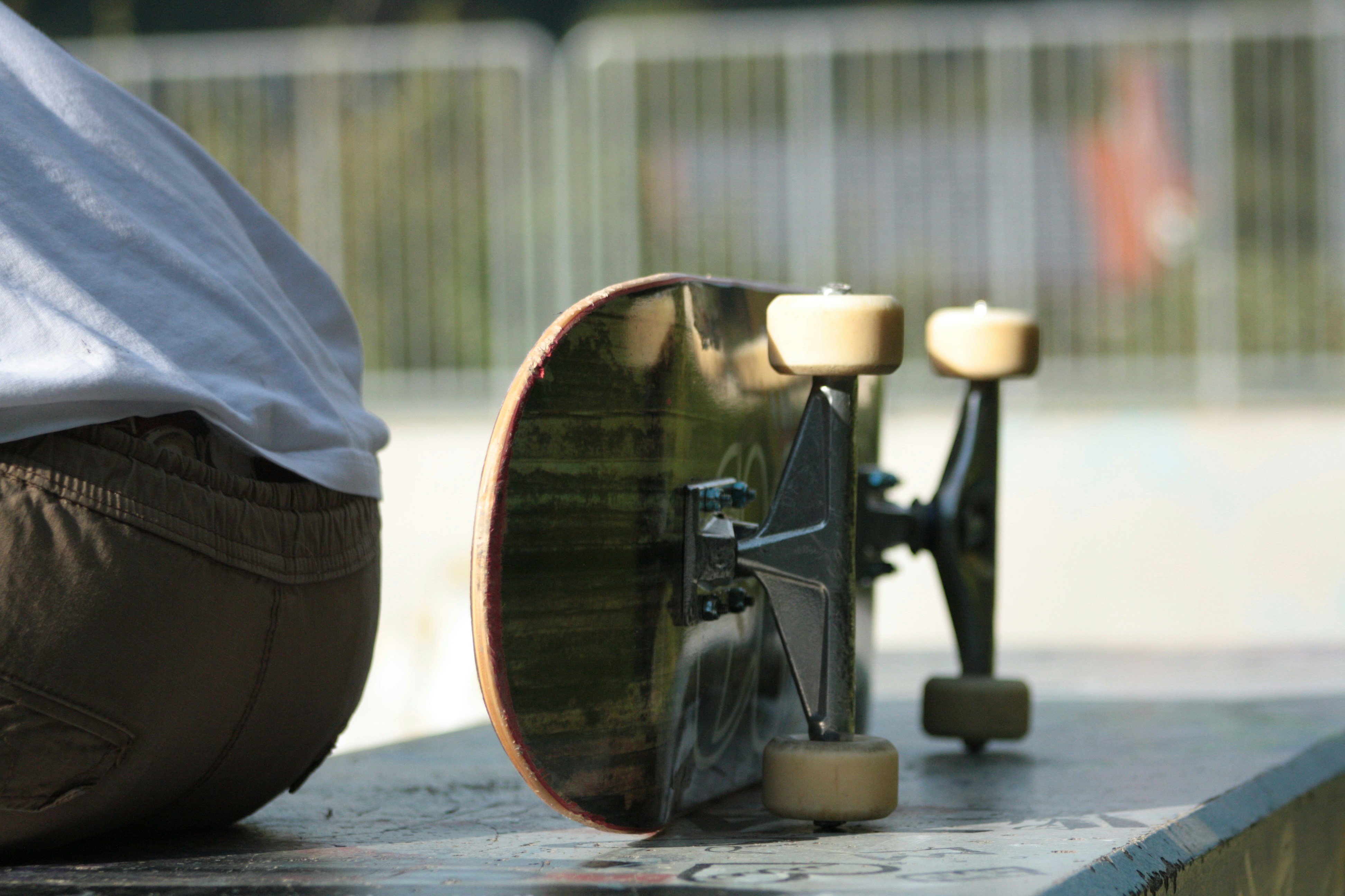 Quiet Repose: Skateboard Leans on the Concrete Edge