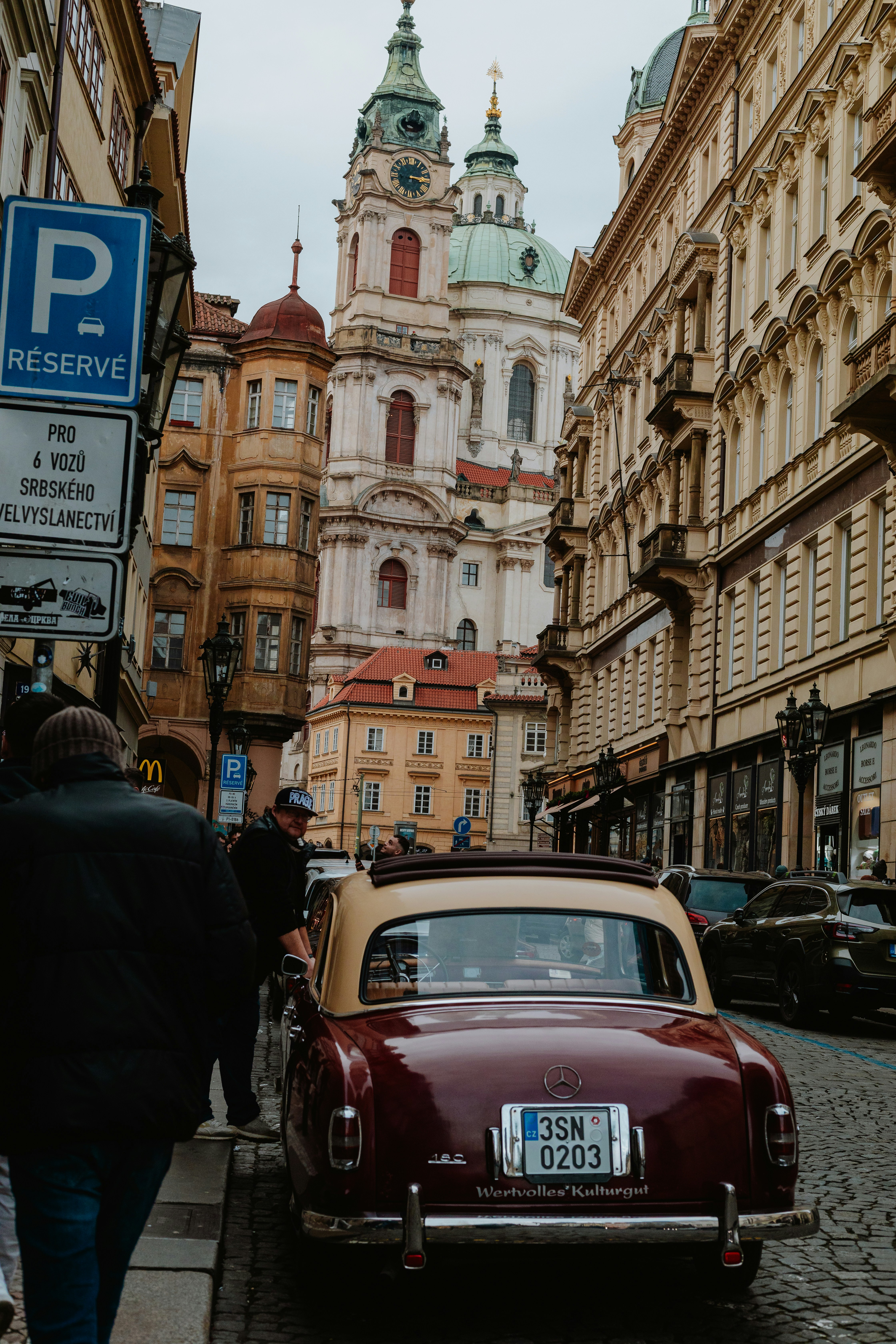Vintage car parked on a european street with architecture.