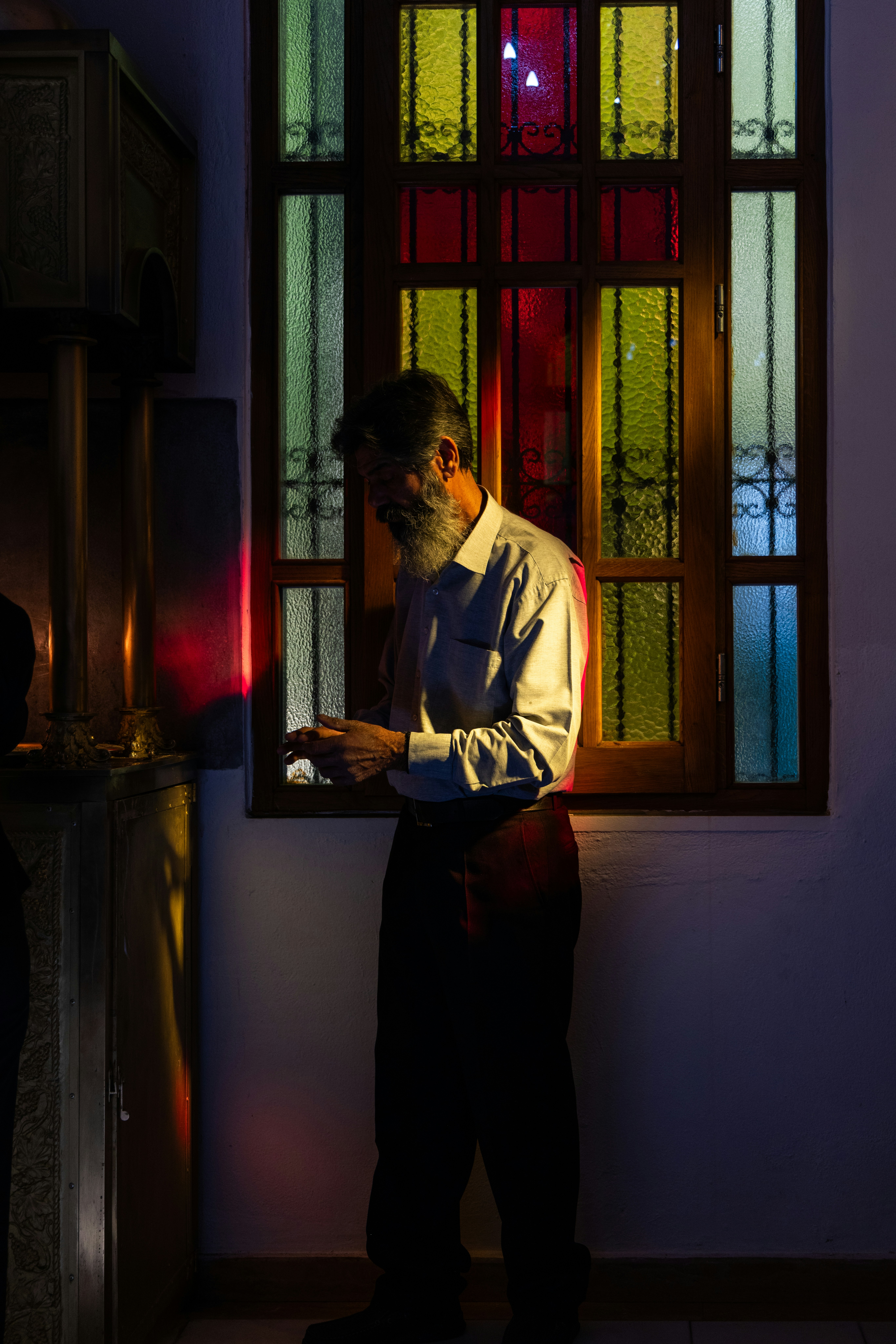 Colored Quiet: A Man Beneath the Stained-Glass Window