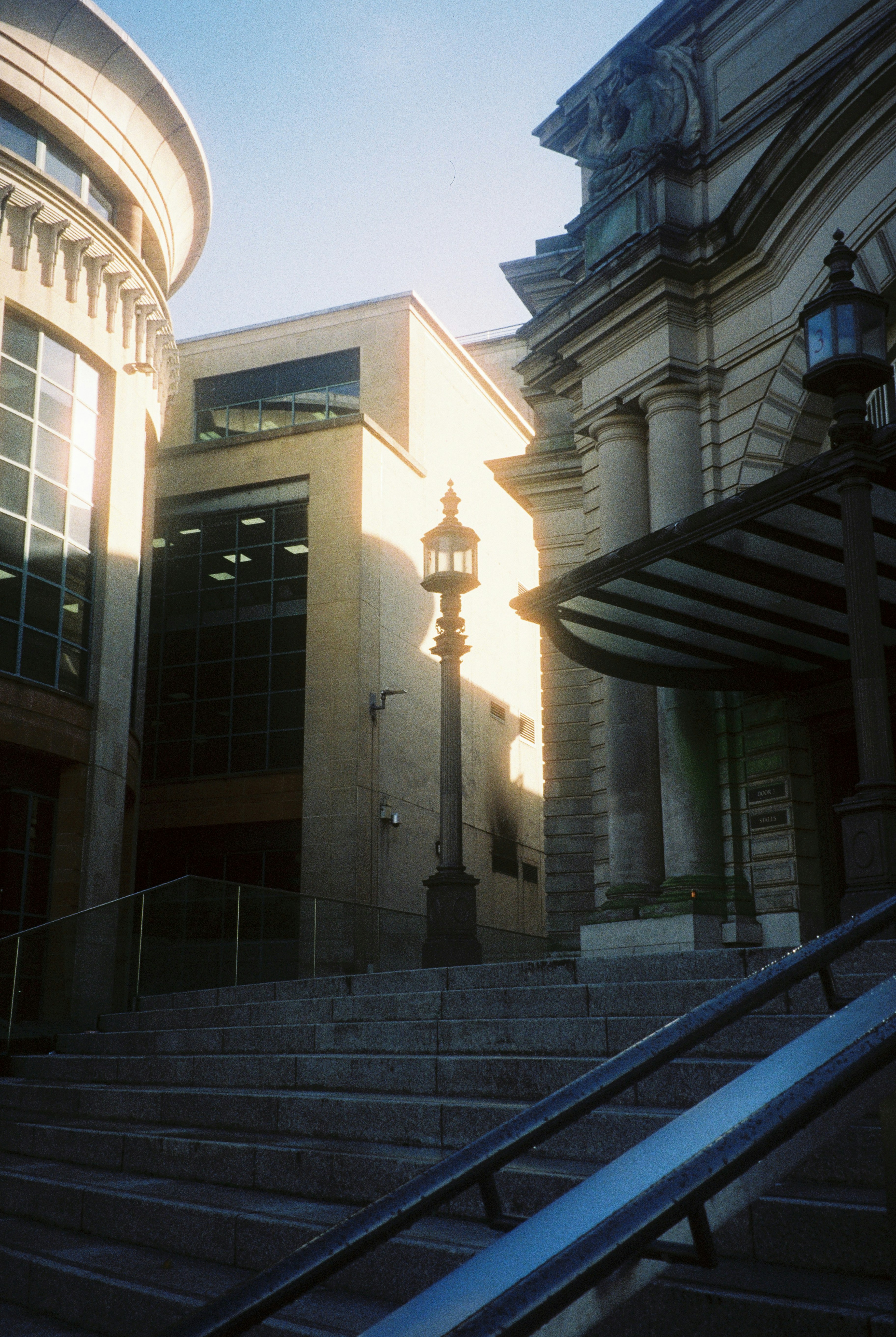 Shot on CineStill 800T | Stone steps leading up to modern buildings and lamppost