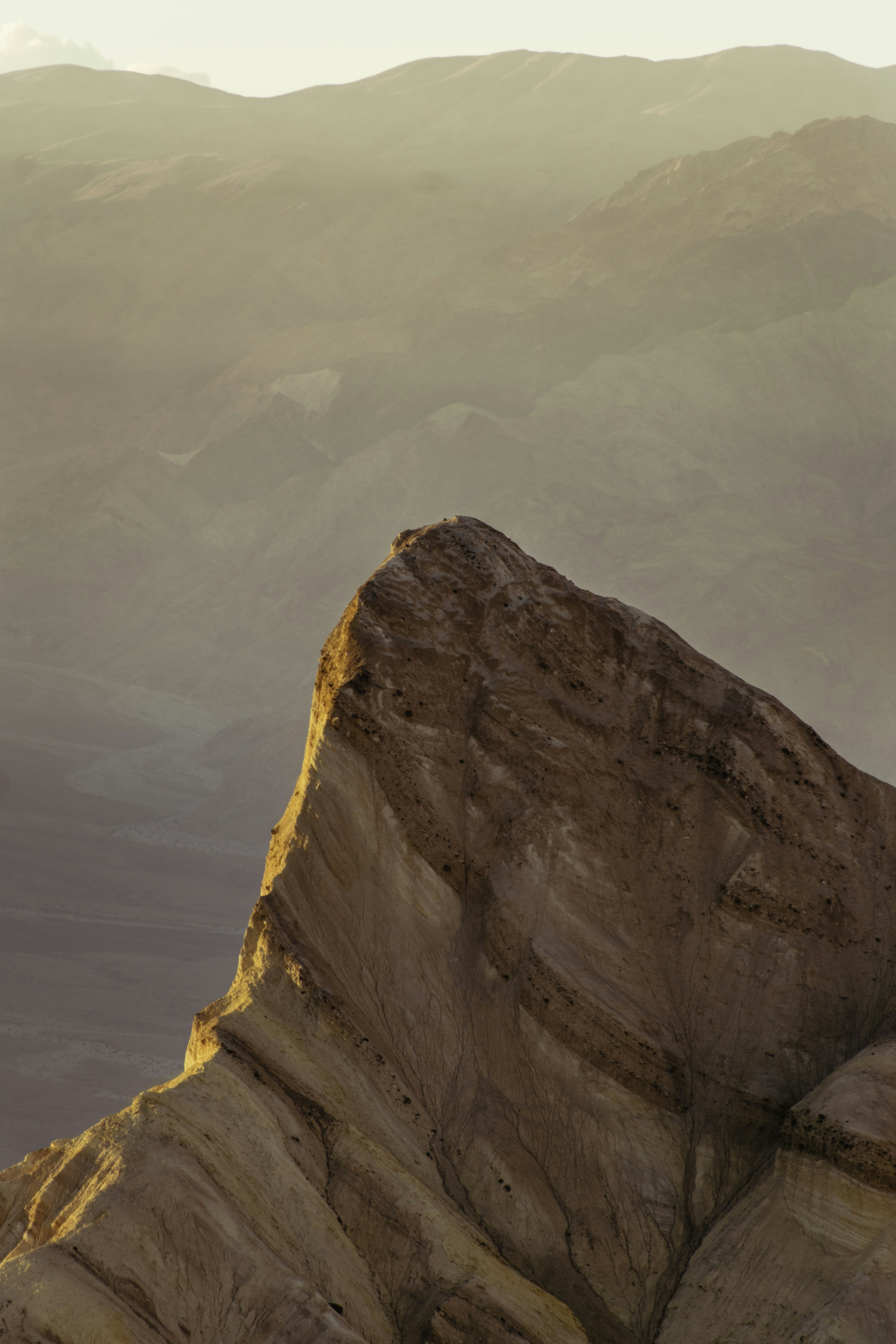 Sunlit mountain peak with layered rock formations
