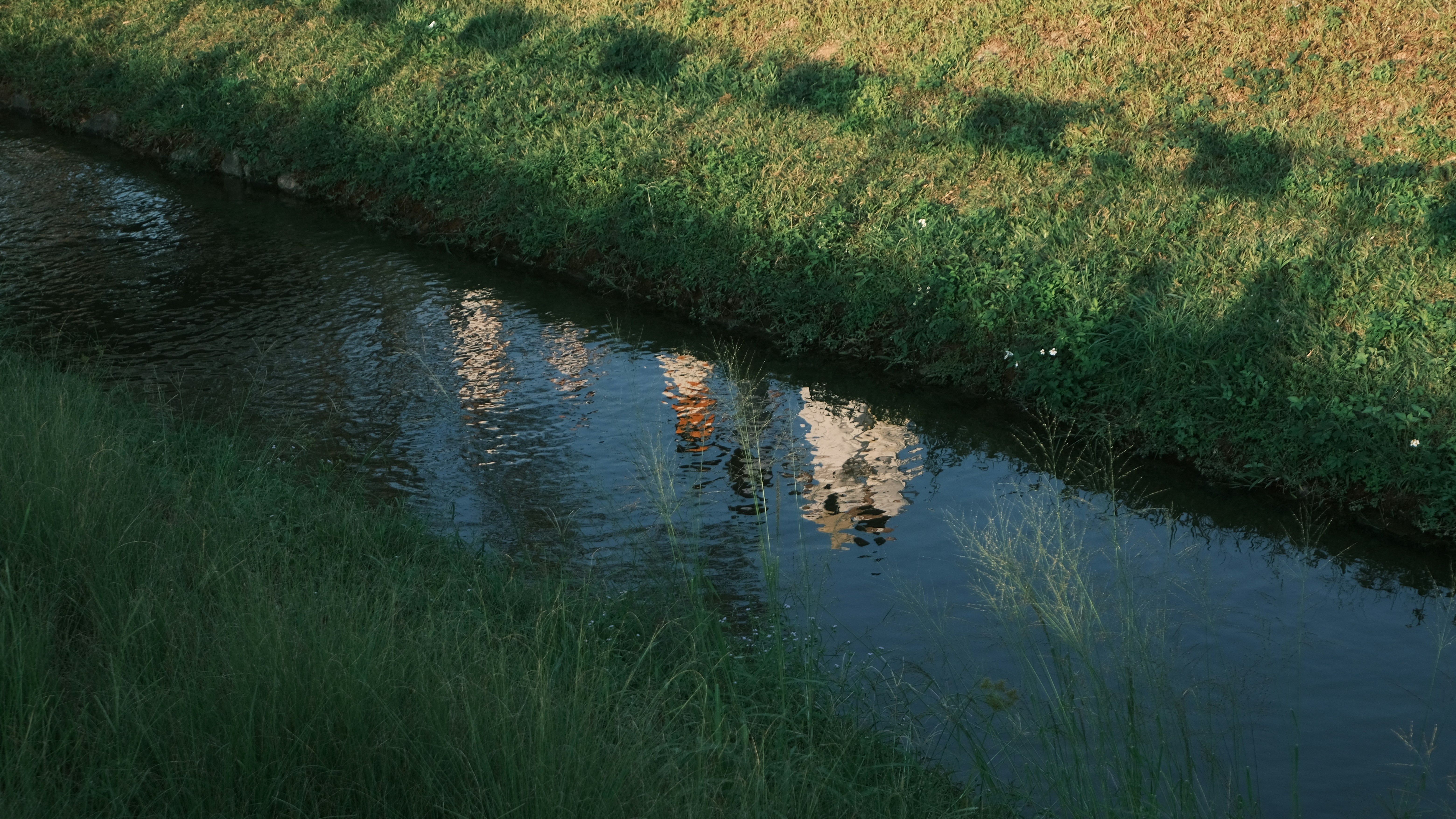 Reflection of a building in a narrow canal