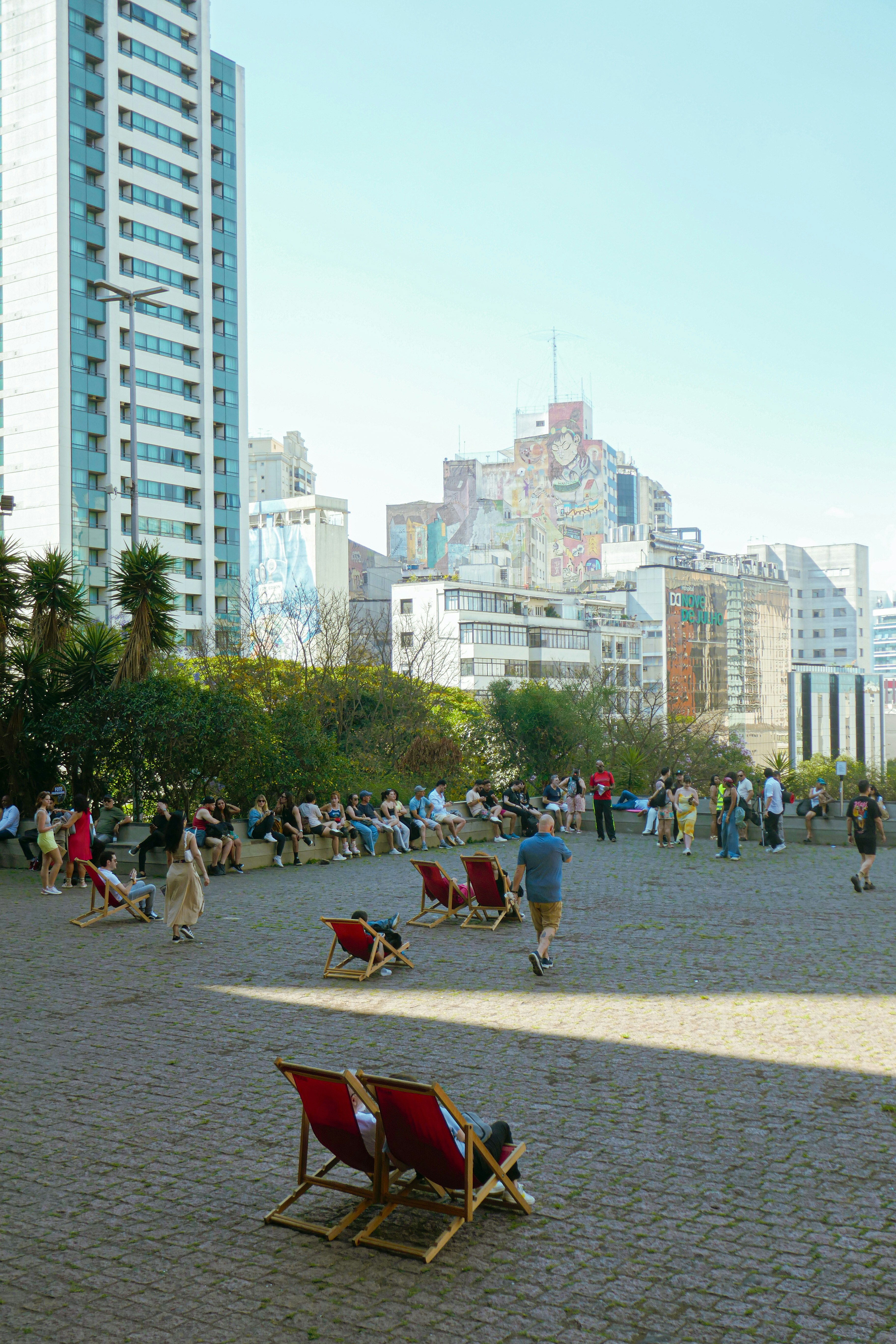 People relaxing in a park with city buildings background