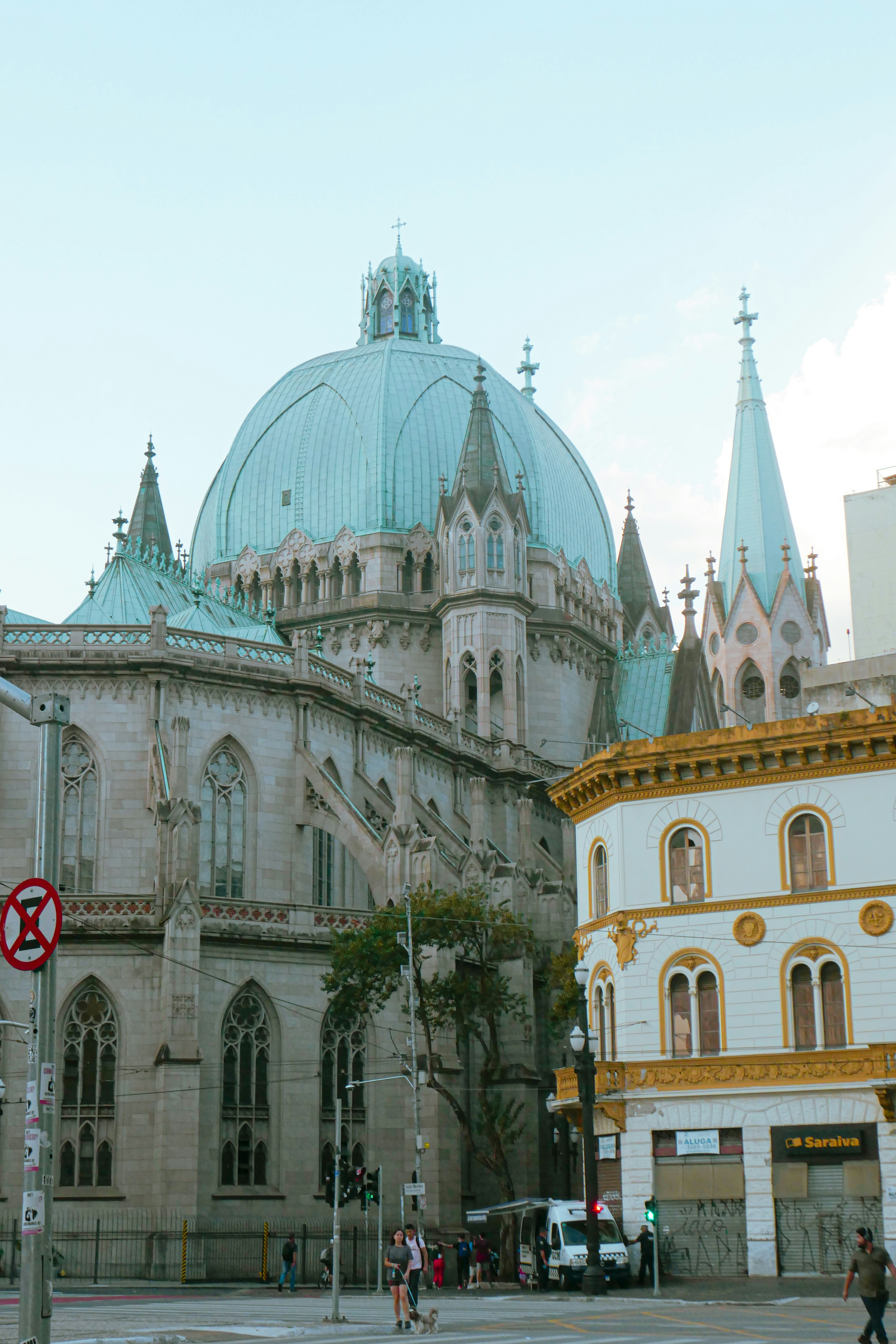Large cathedral with a green dome and ornate facade.