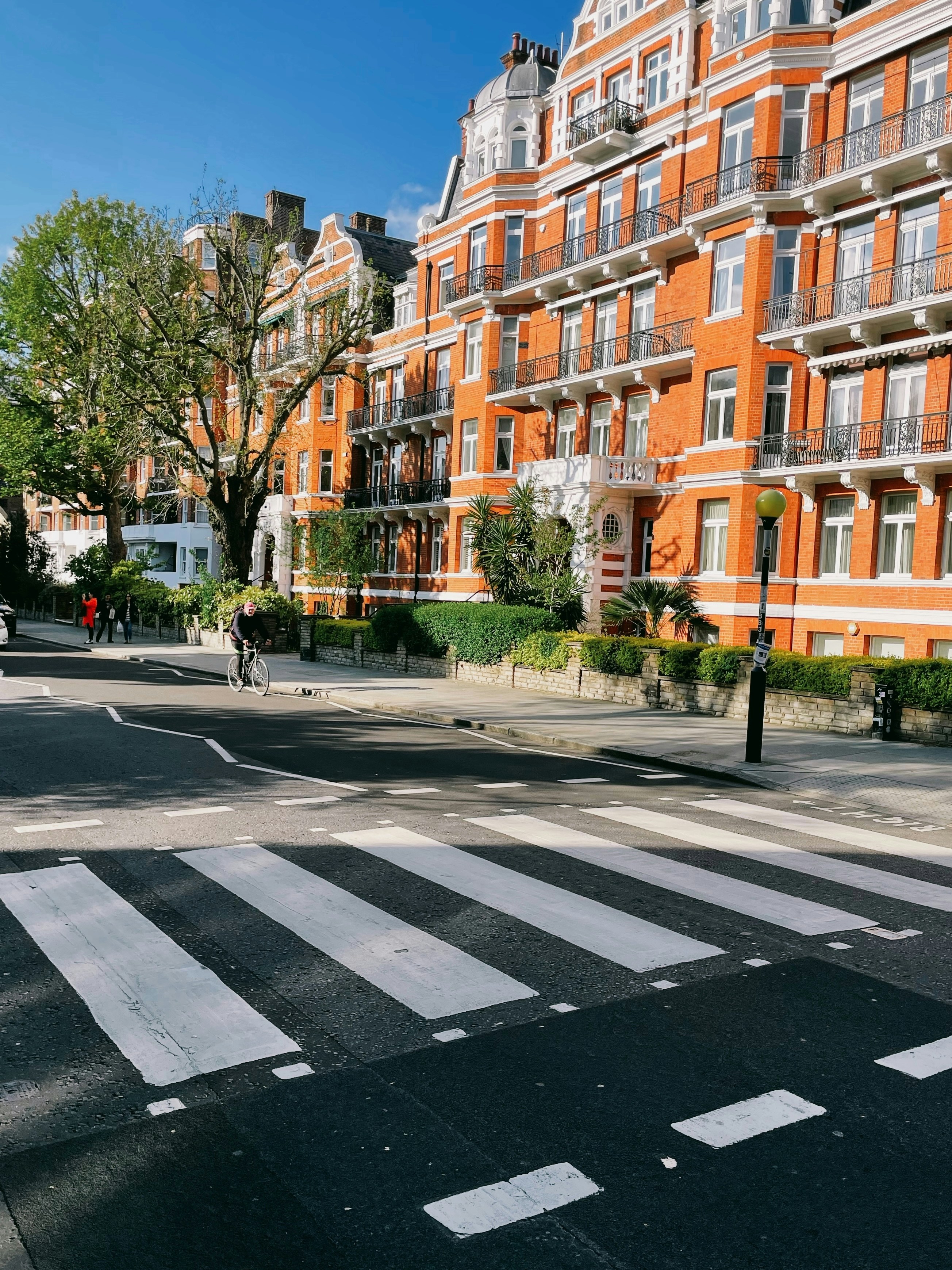 Orange buildings line a street with a crosswalk. photo – Free ...