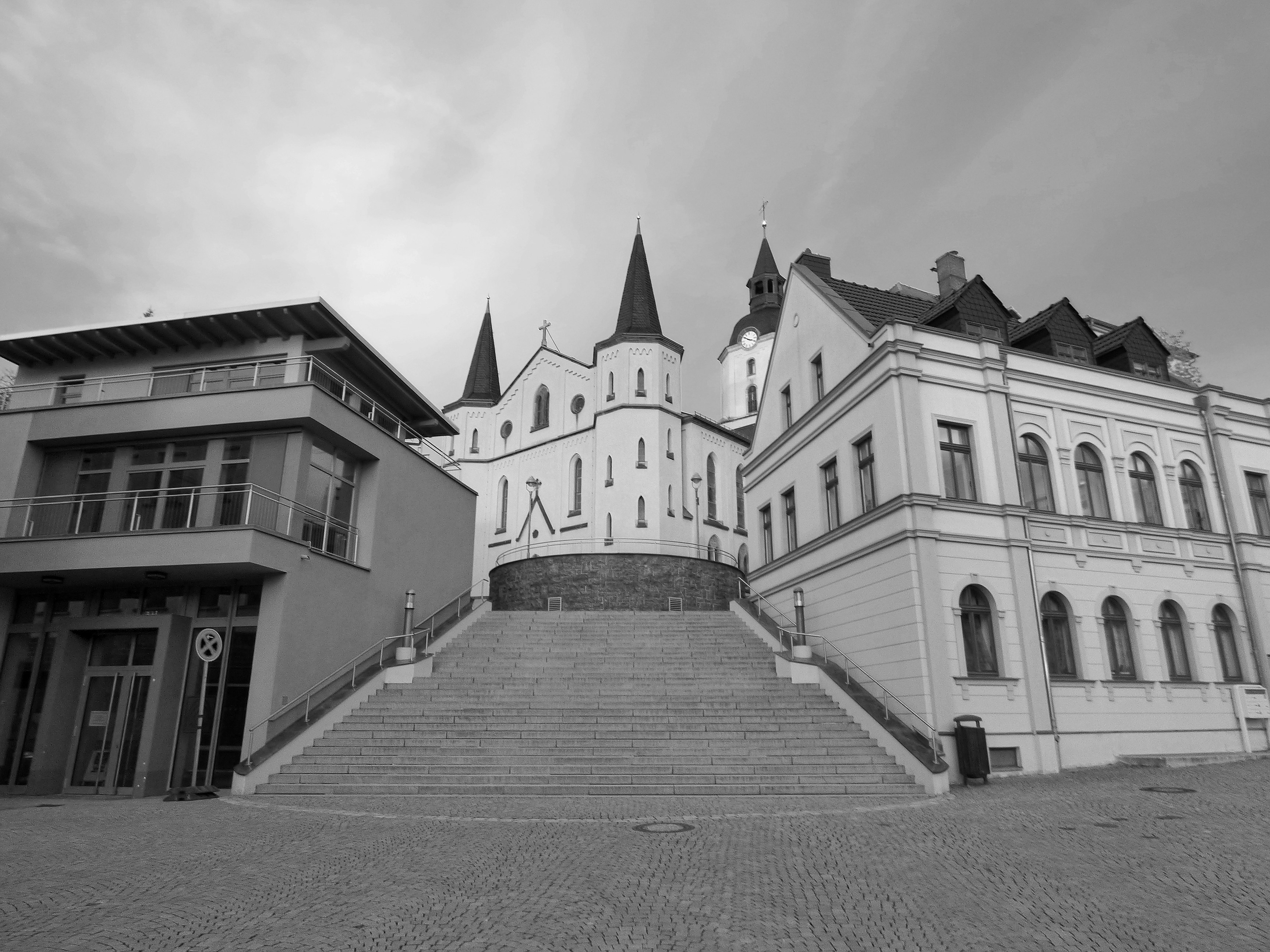 Gothic-style church rises majestically above modern buildings, showcasing a blend of historical and contemporary architecture. The scene captures the essence of urban evolution.