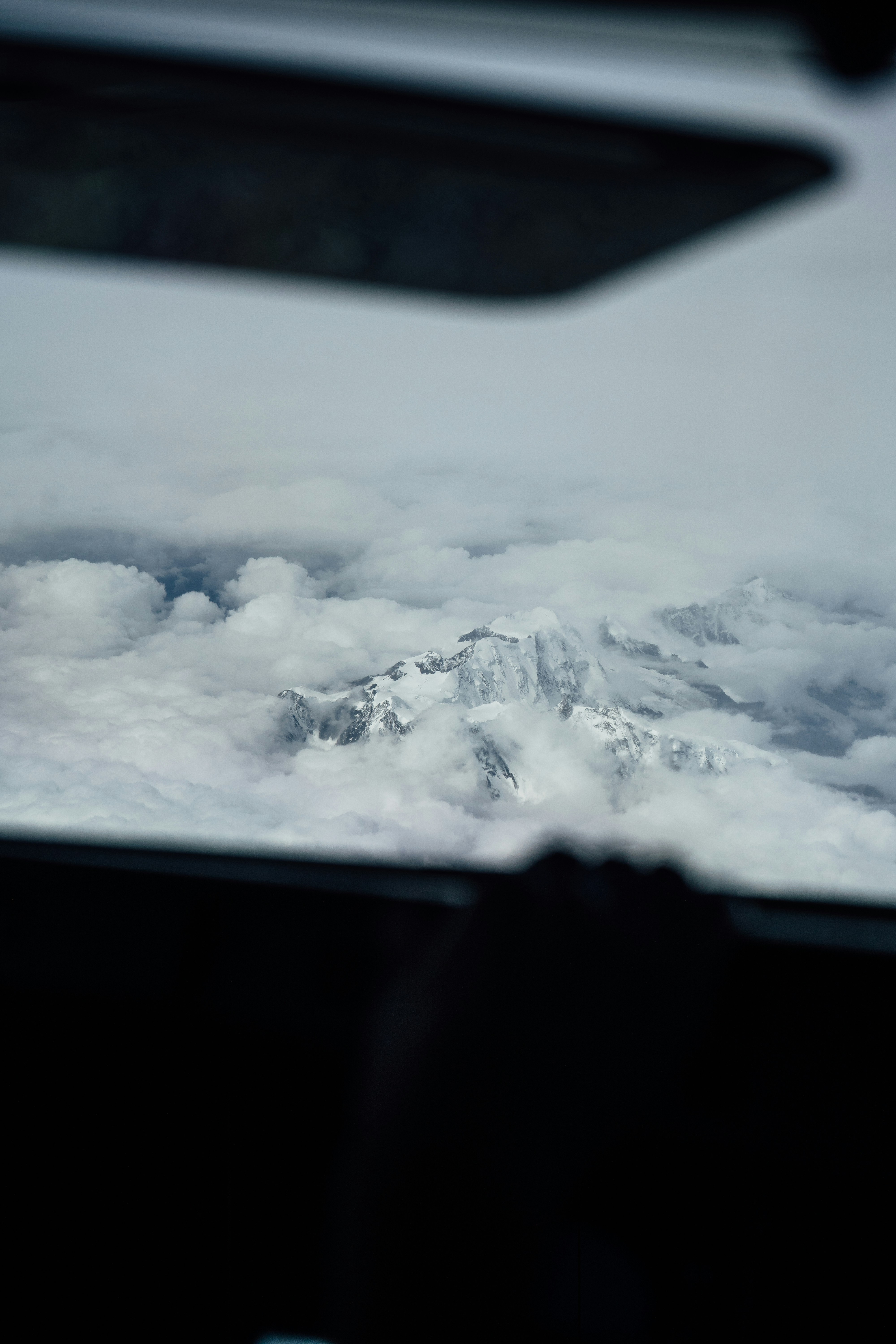 Veil of Clouds Over Majestic Peaks