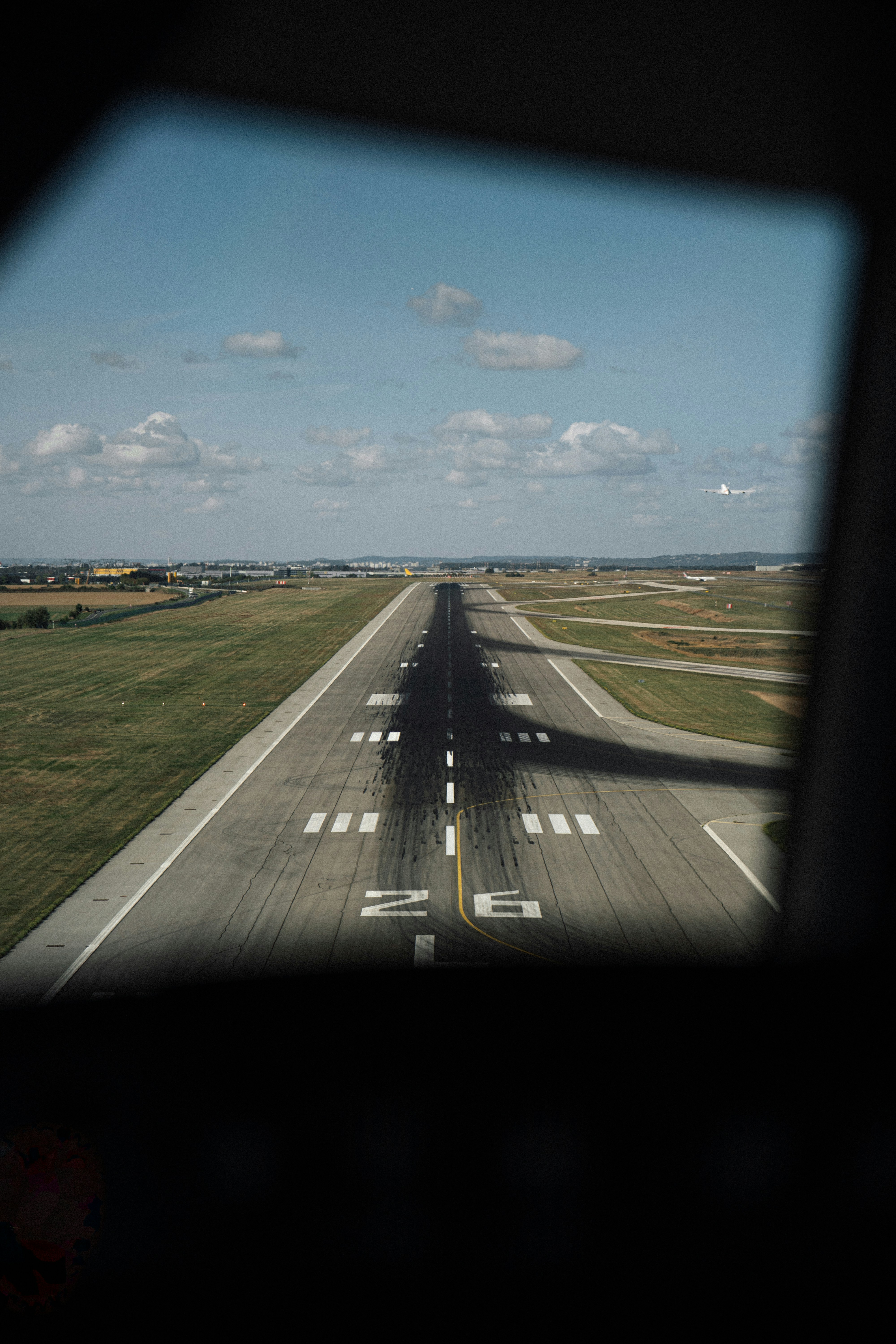 Wing Shadow over a Quiet Runway: A Vanishing Line Toward the Horizon