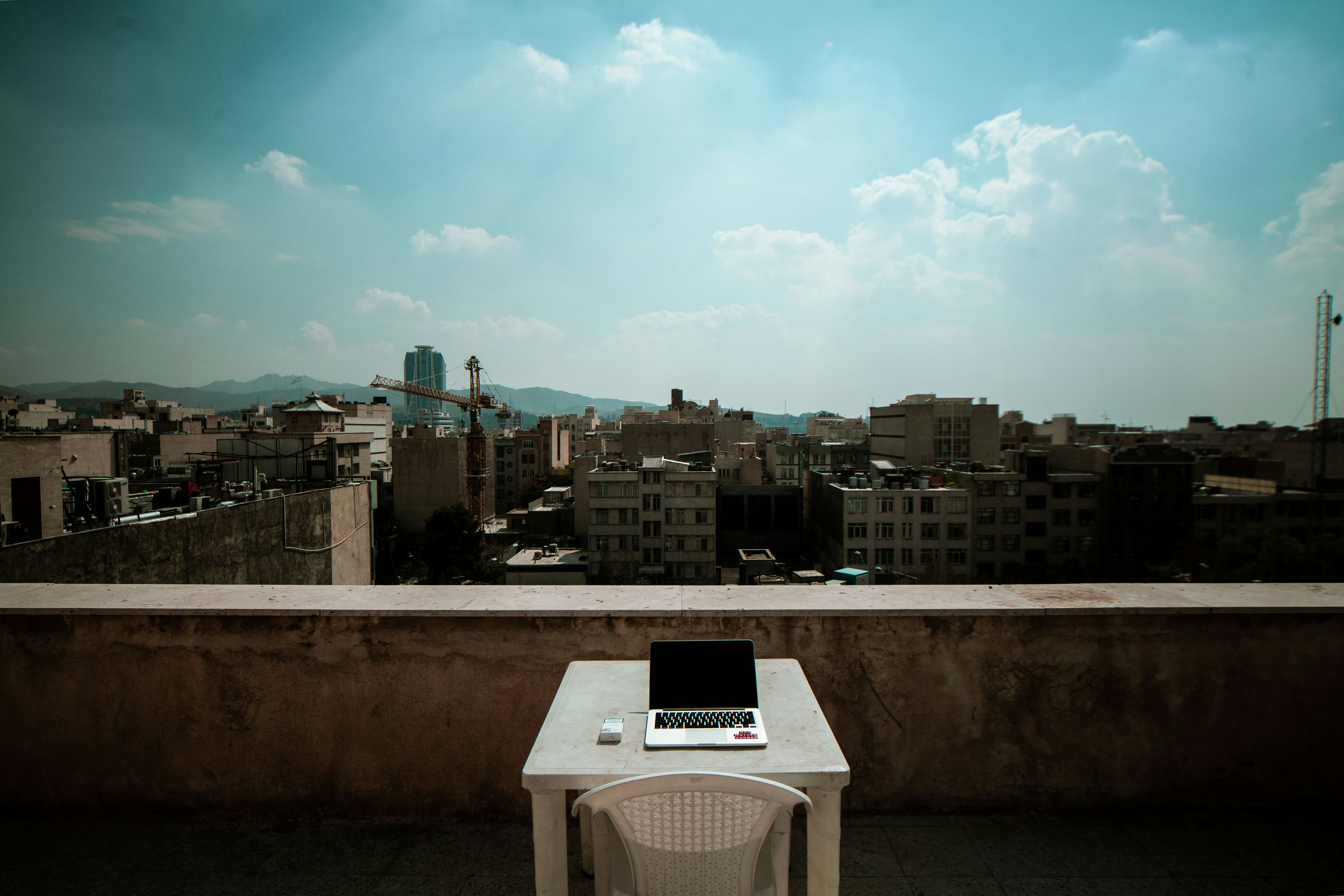 During the COVID era, I used to work like this sometimes just so I wouldn’t go crazy. | Laptop on table overlooking city skyline