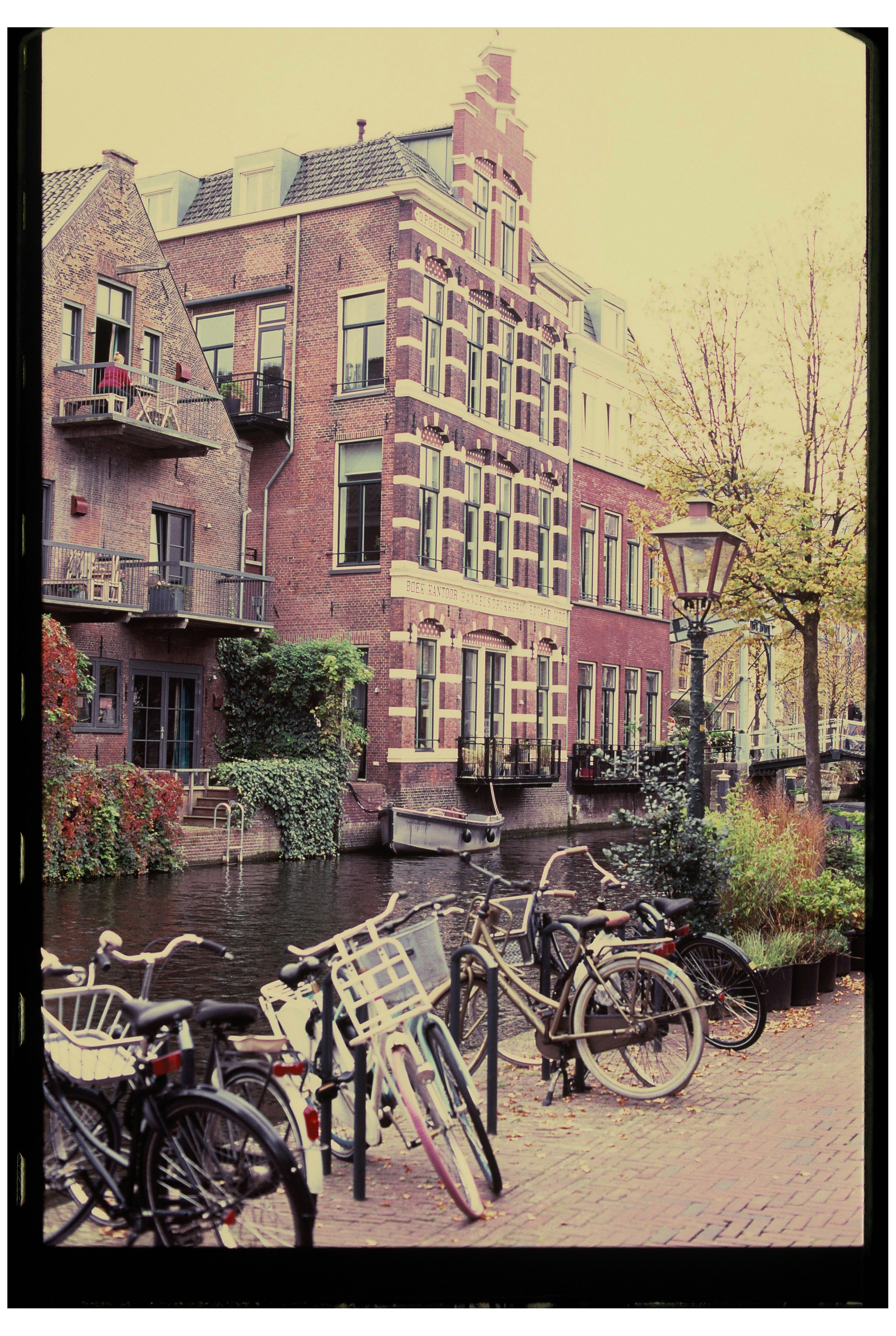 Gabled Dutch Canal: Bikes, Reflections, and Golden Evening Light