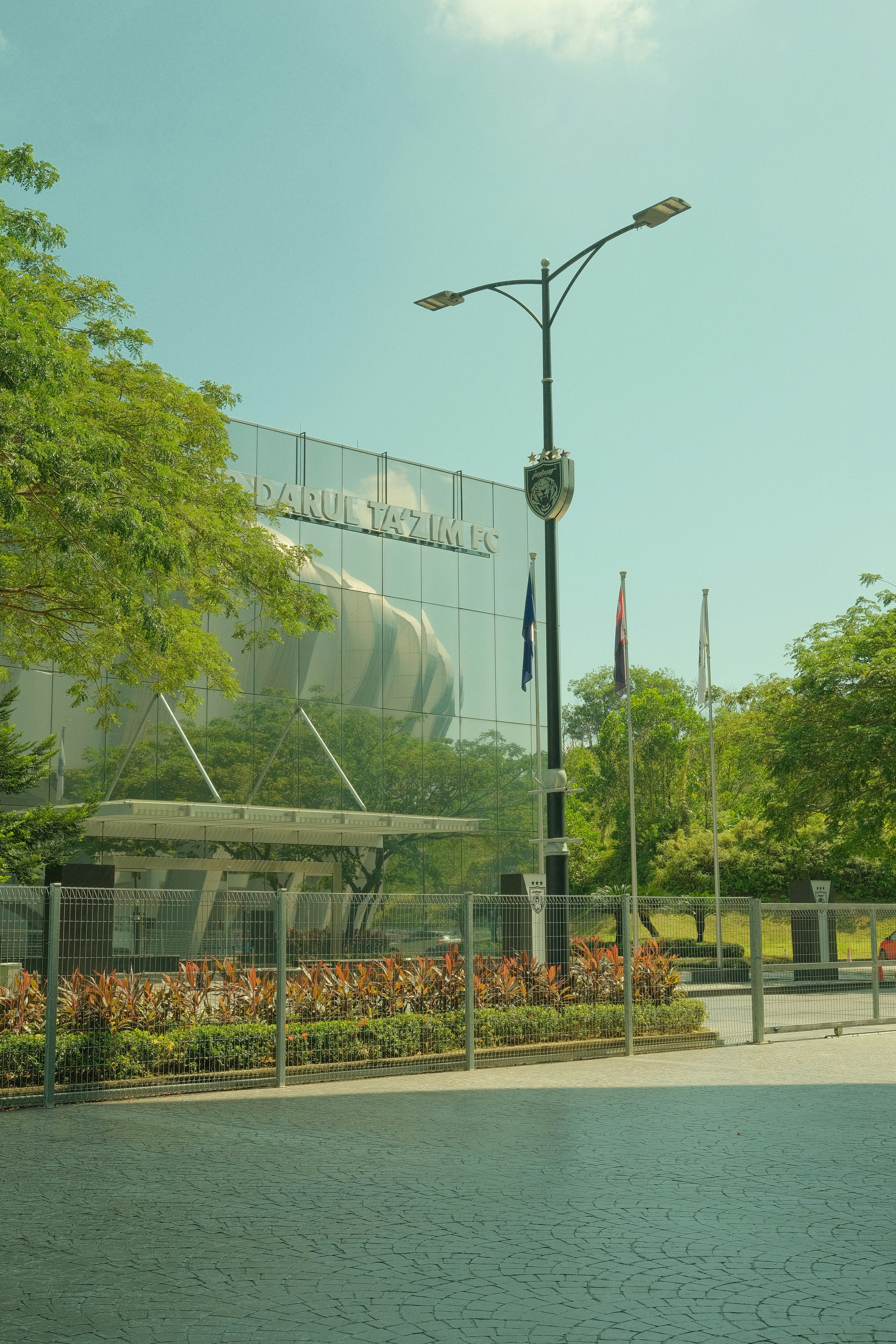 Modern building with trees and a street light.