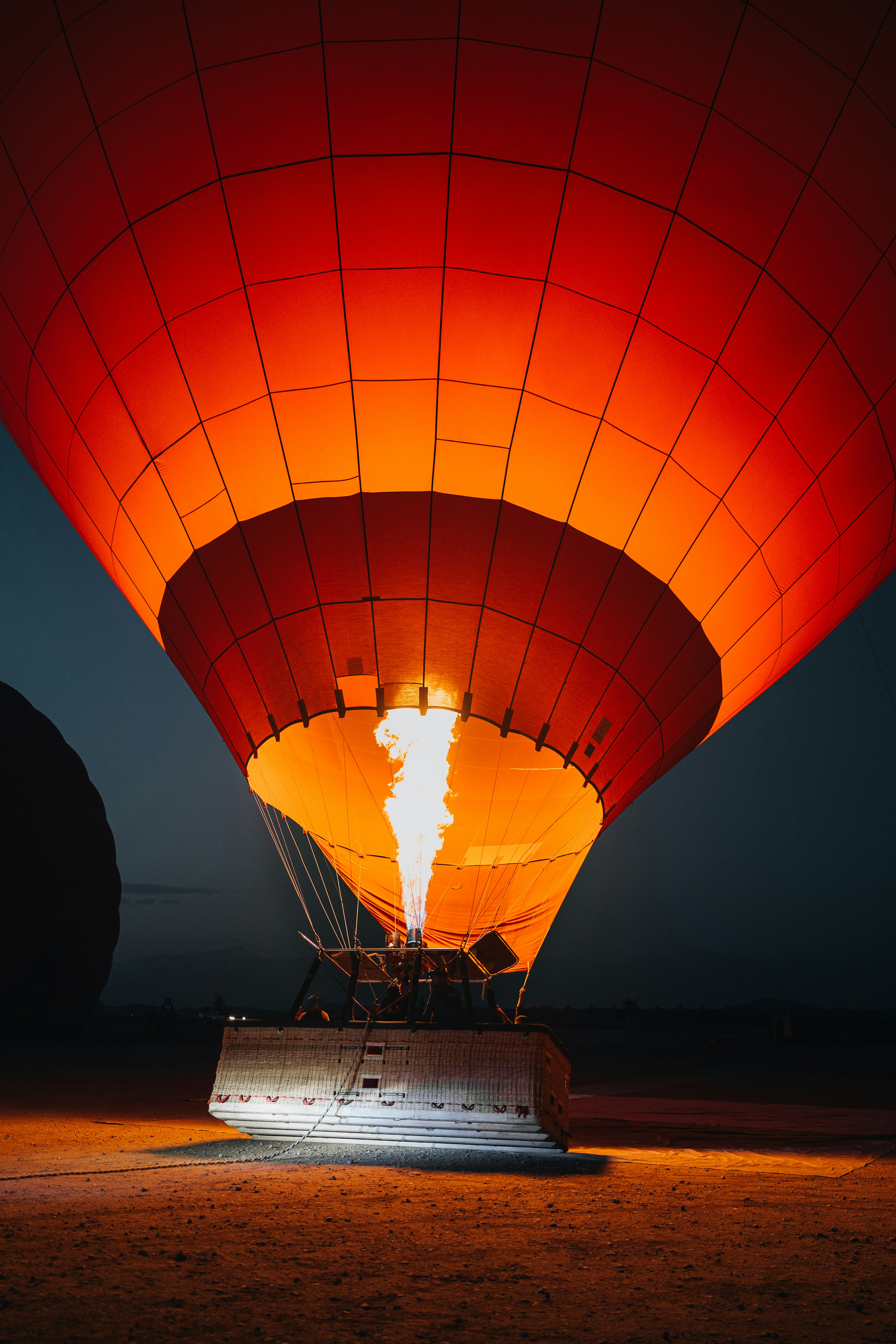 Ignition of Adventure: A Hot Air Balloon's Nighttime Ascent