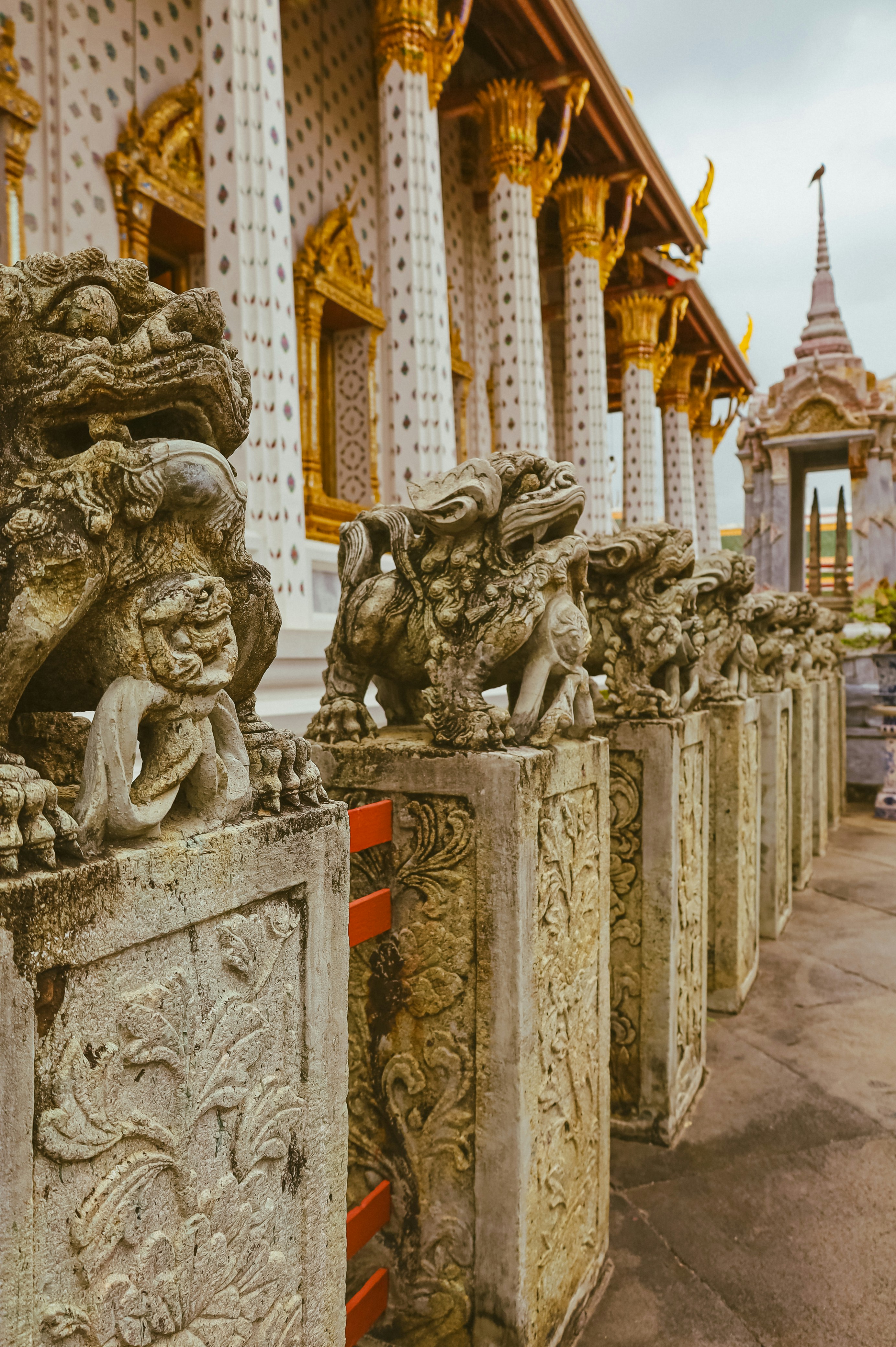 Stone lion statues line a temple walkway