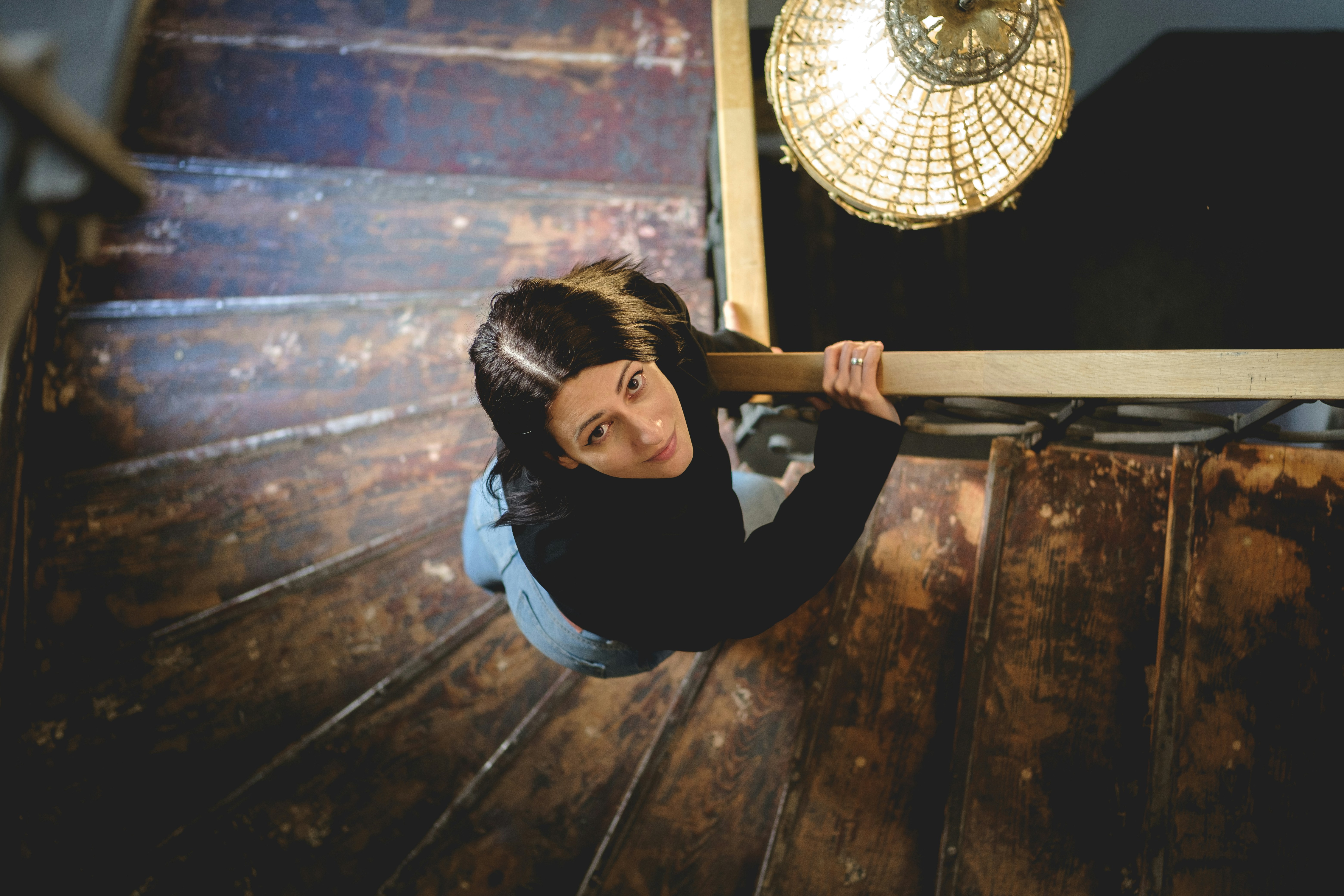 Staircase stare. | Woman on a spiral staircase holding railing
