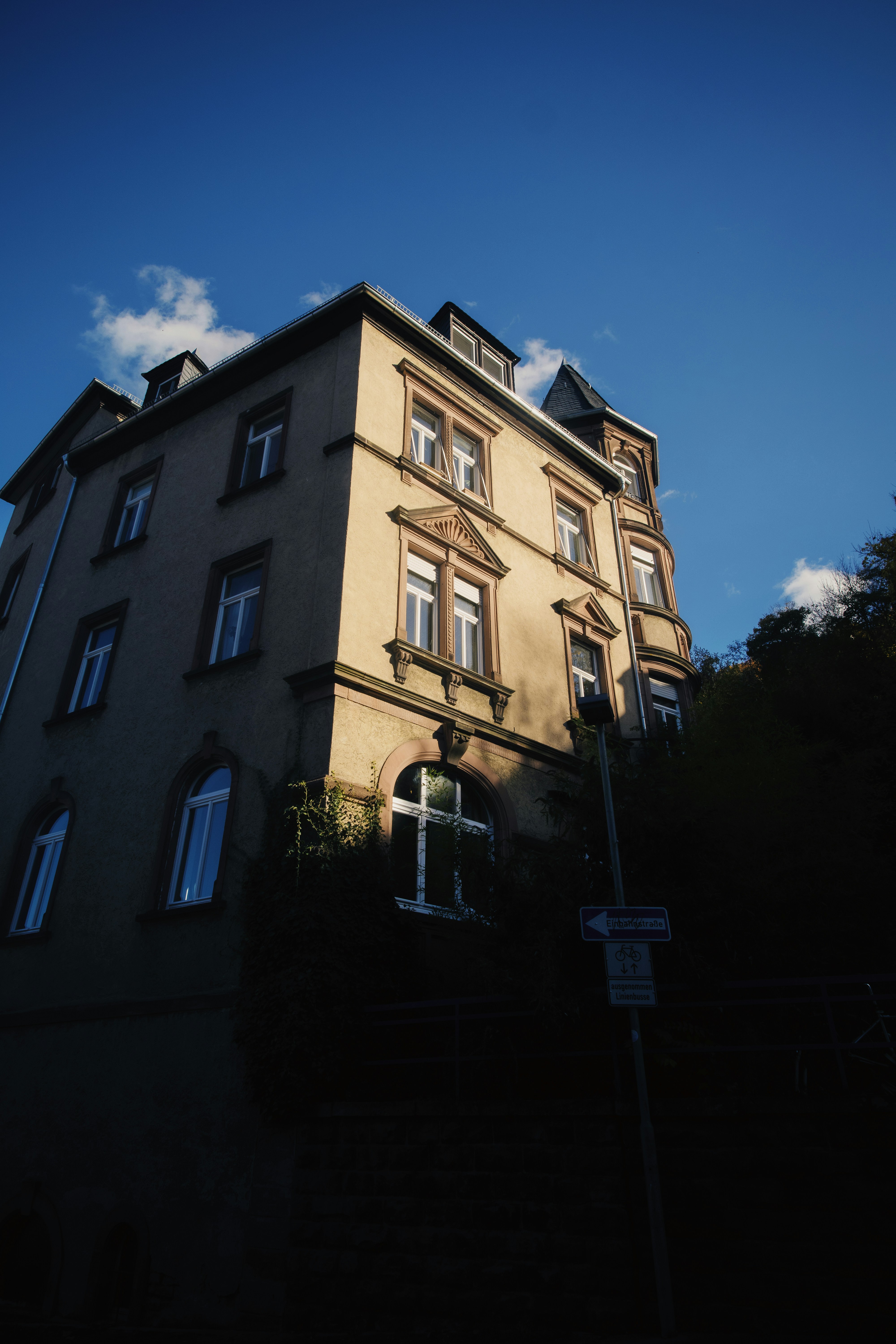 A building corner against a bright blue sky.
