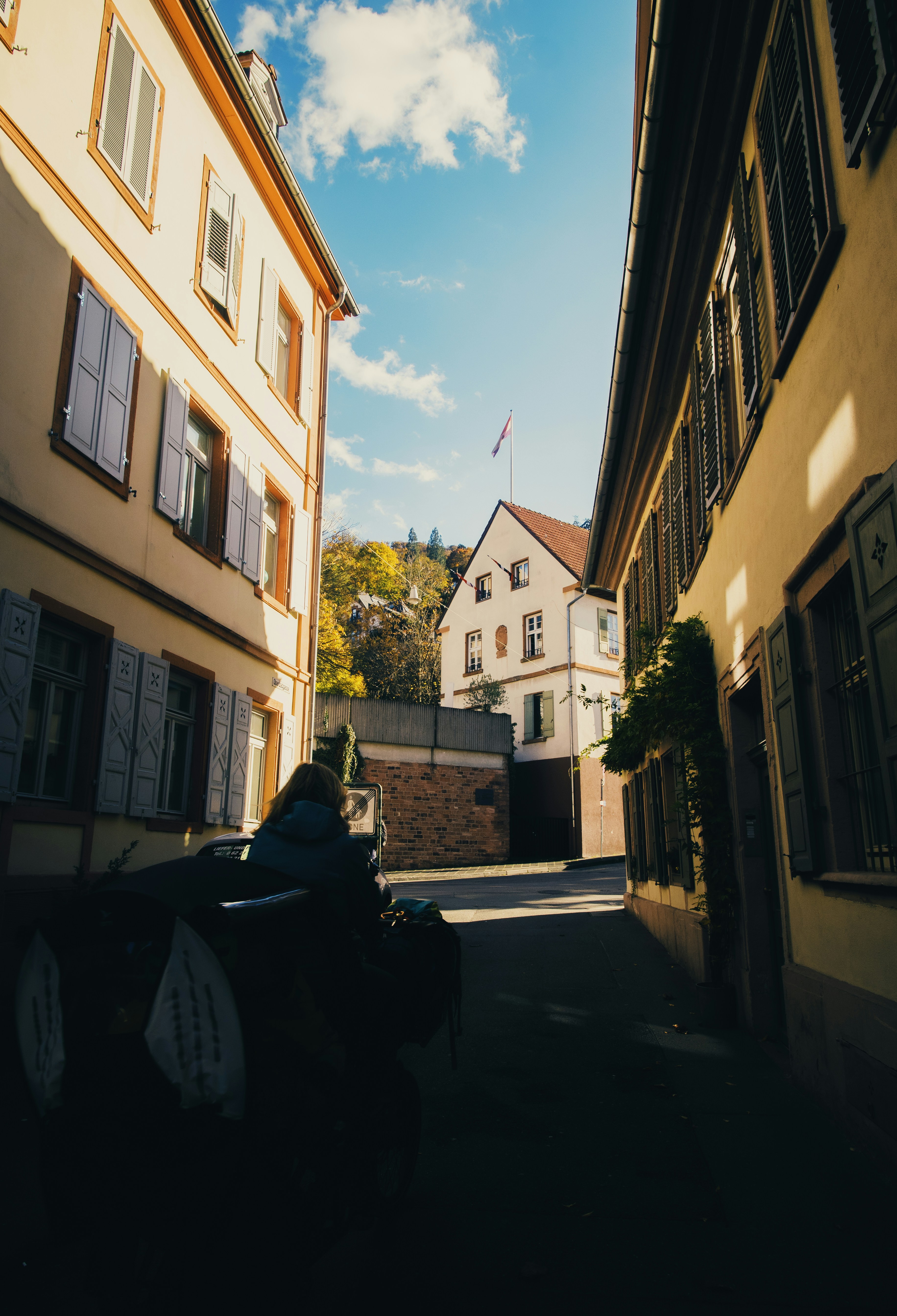 Sunlit alleyway between old european buildings