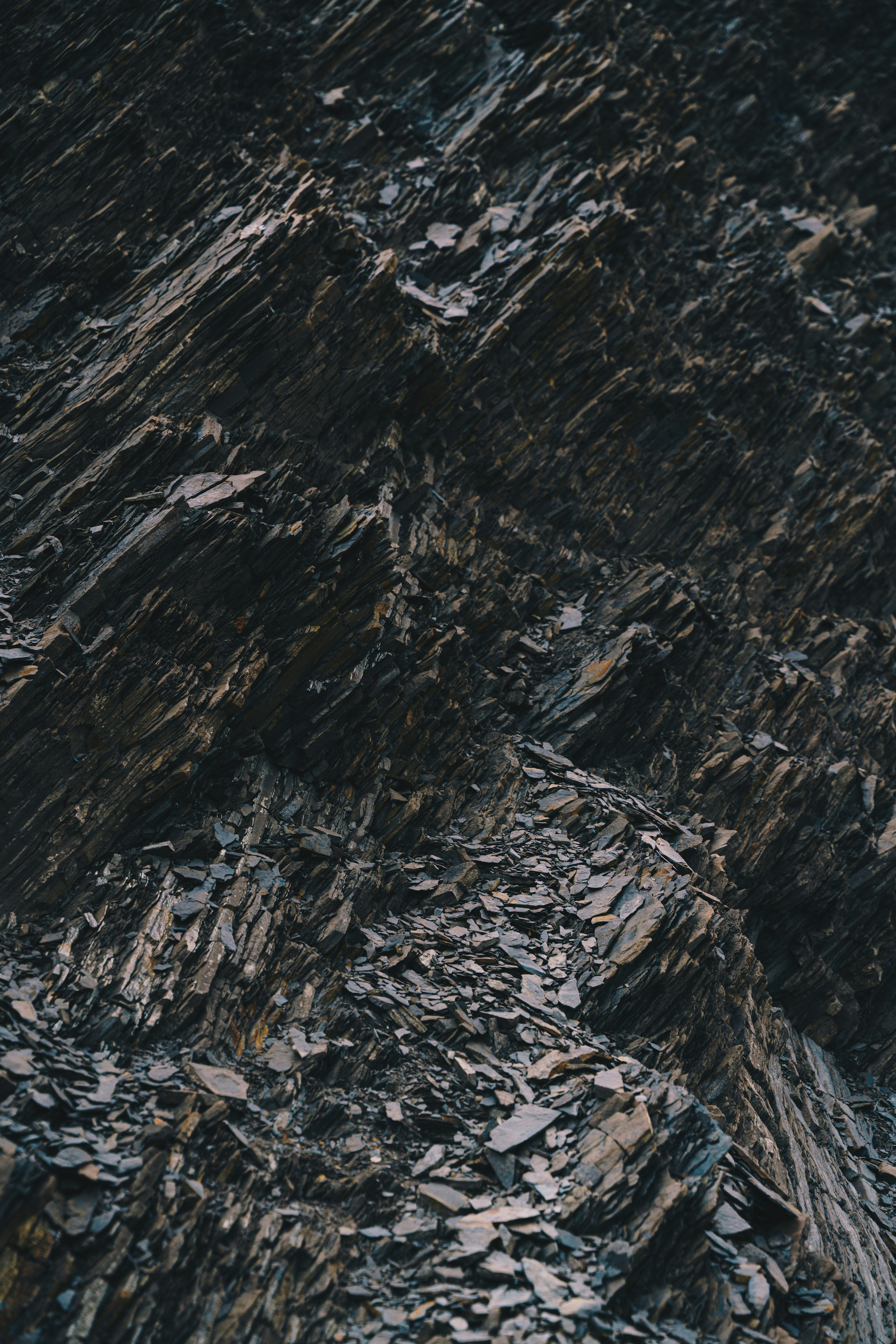Layered dark rock formation with sharp edges