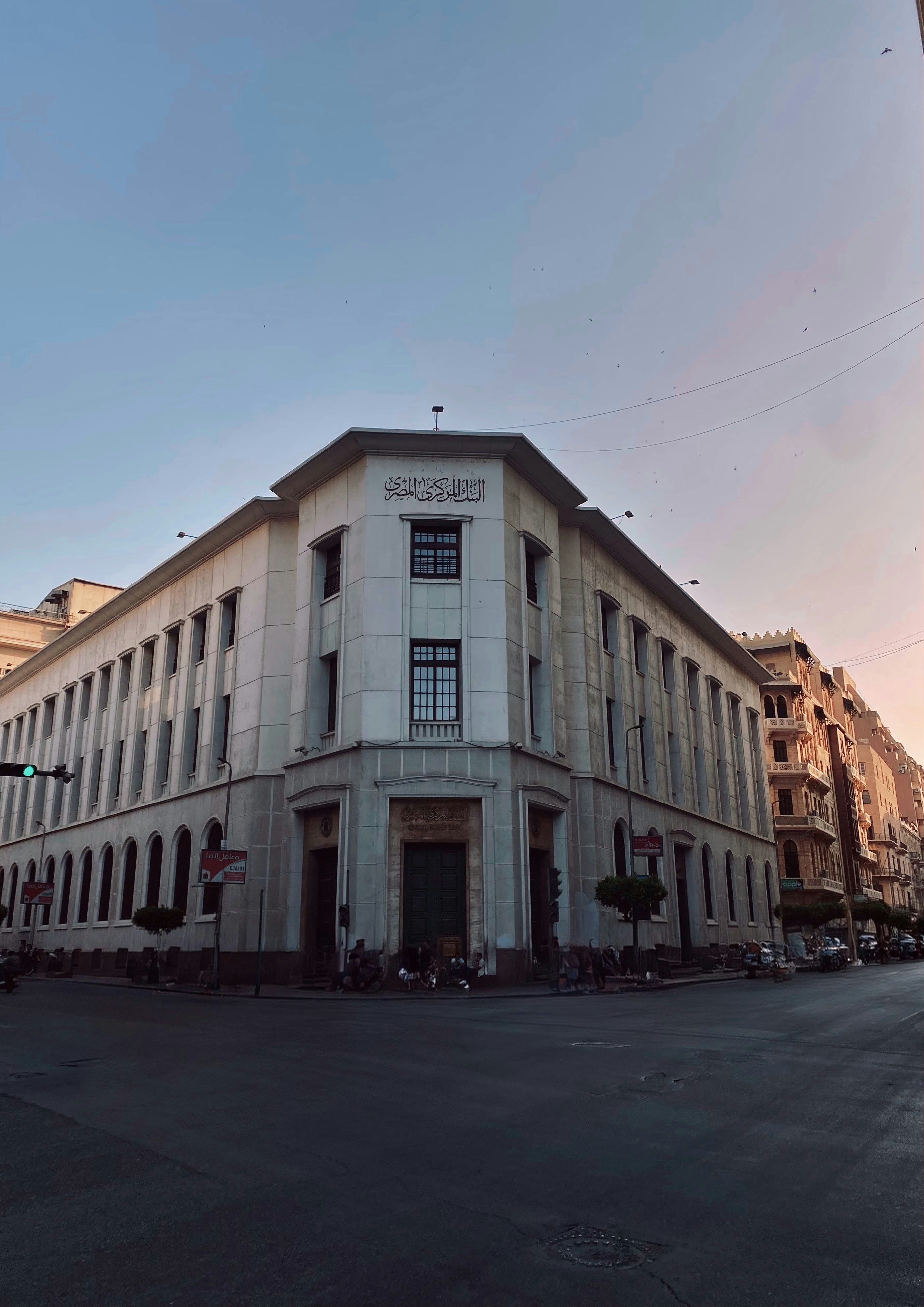 Corner building with classical architecture under a clear sky