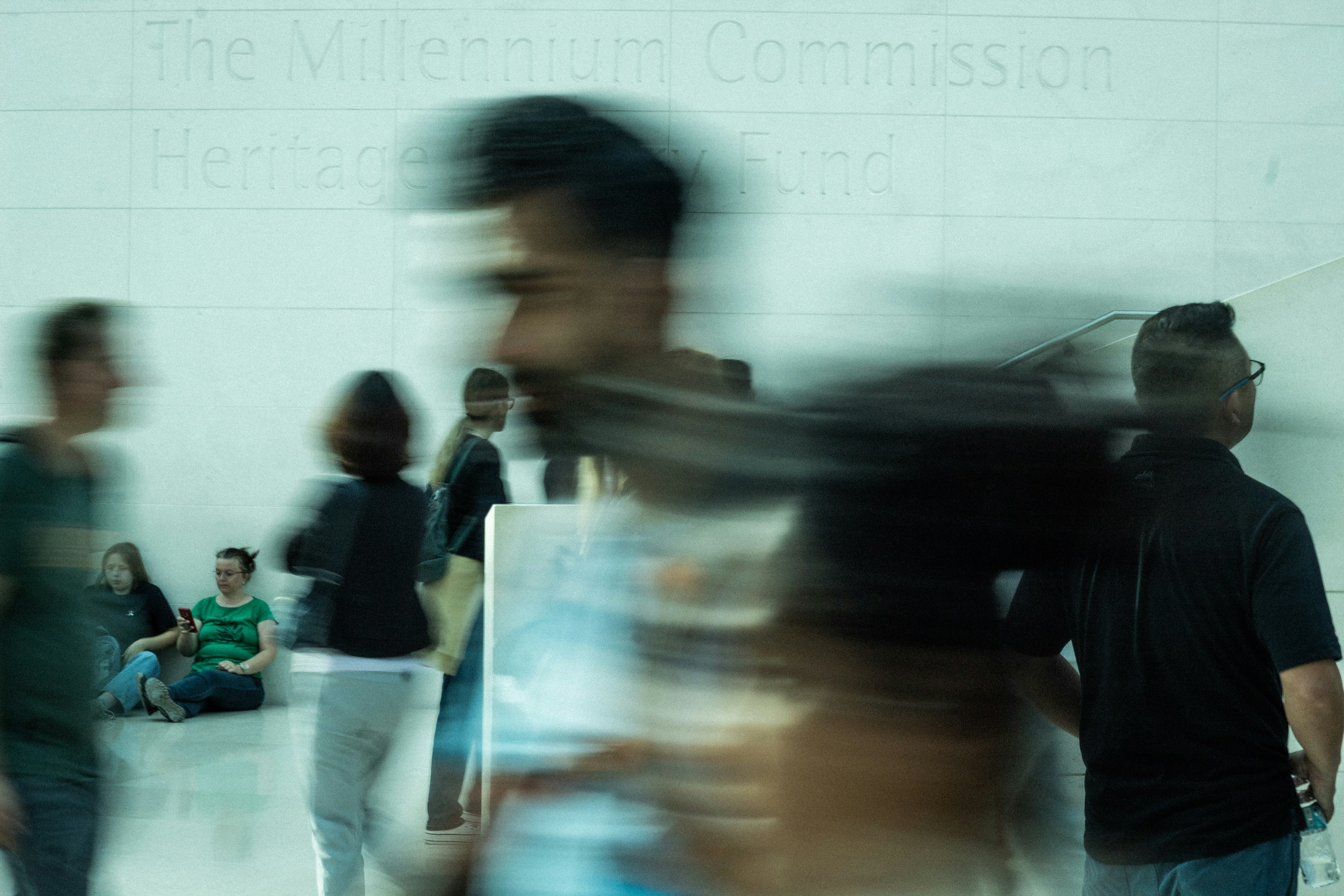 A dynamic scene capturing the hustle and bustle of people in motion within a modern architectural space.
