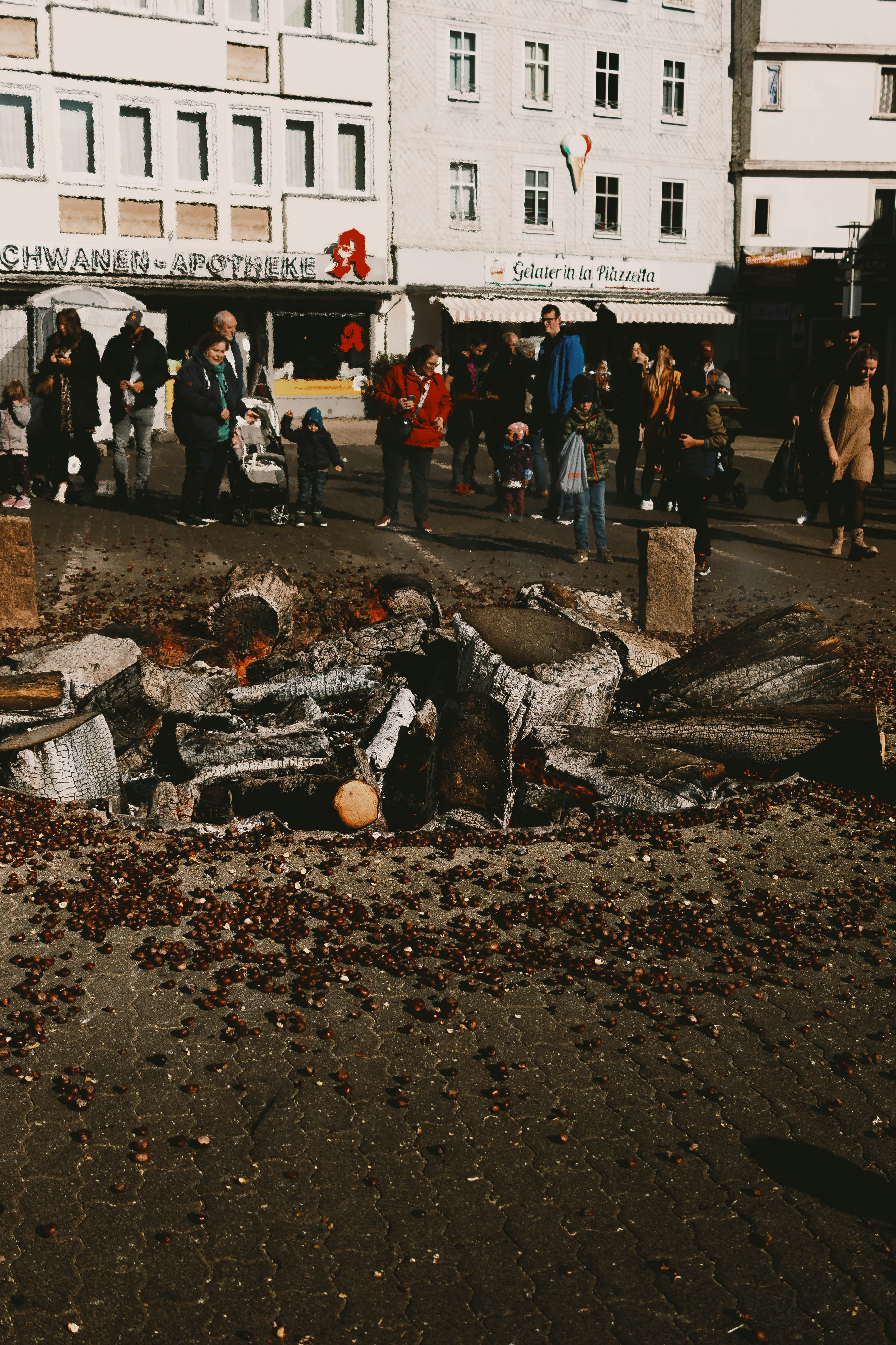 City Square Pyre: Crowds Gather Around a Smoldering Debris Ring