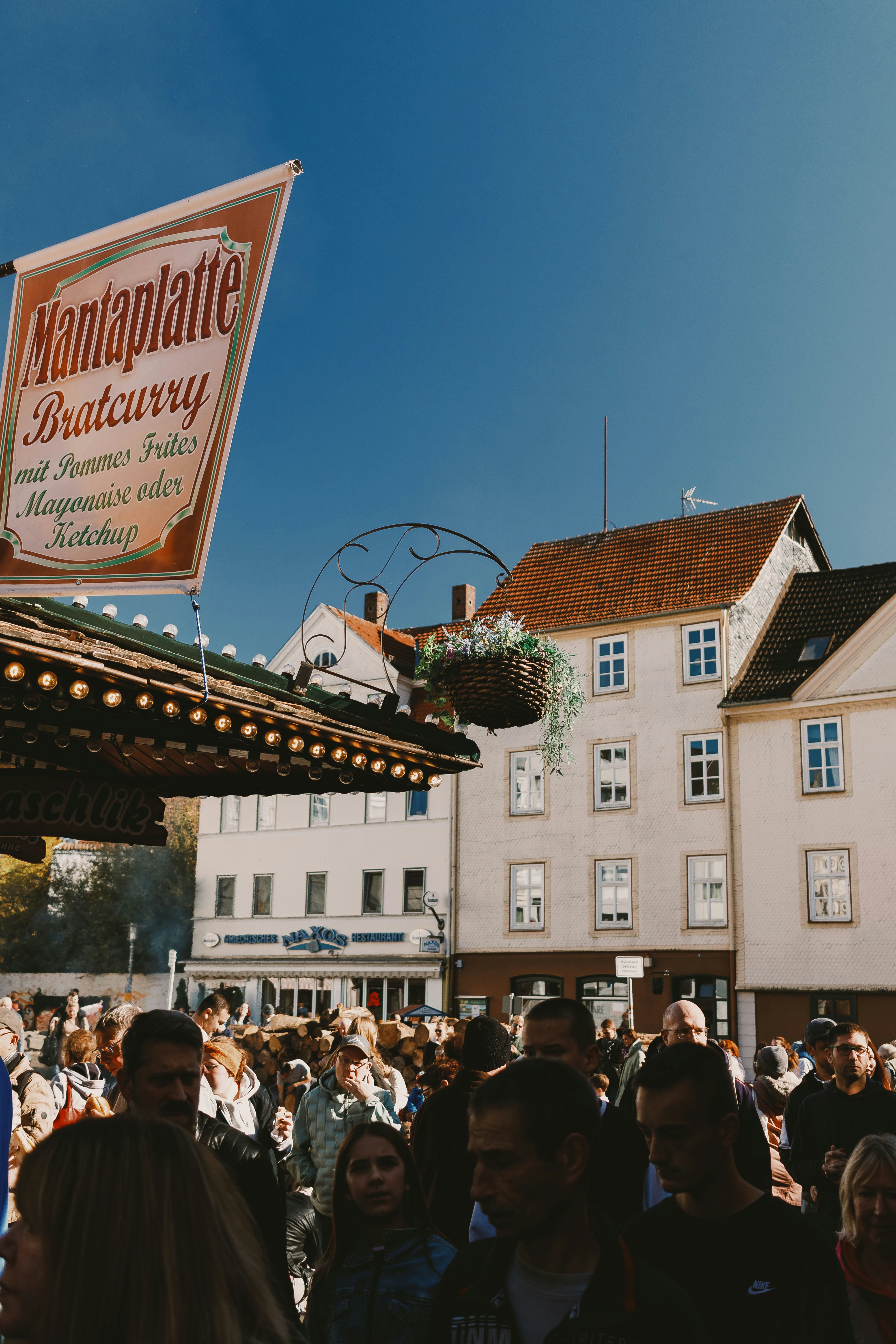 Crowded street market with buildings and food stall sign. photo – Free ...
