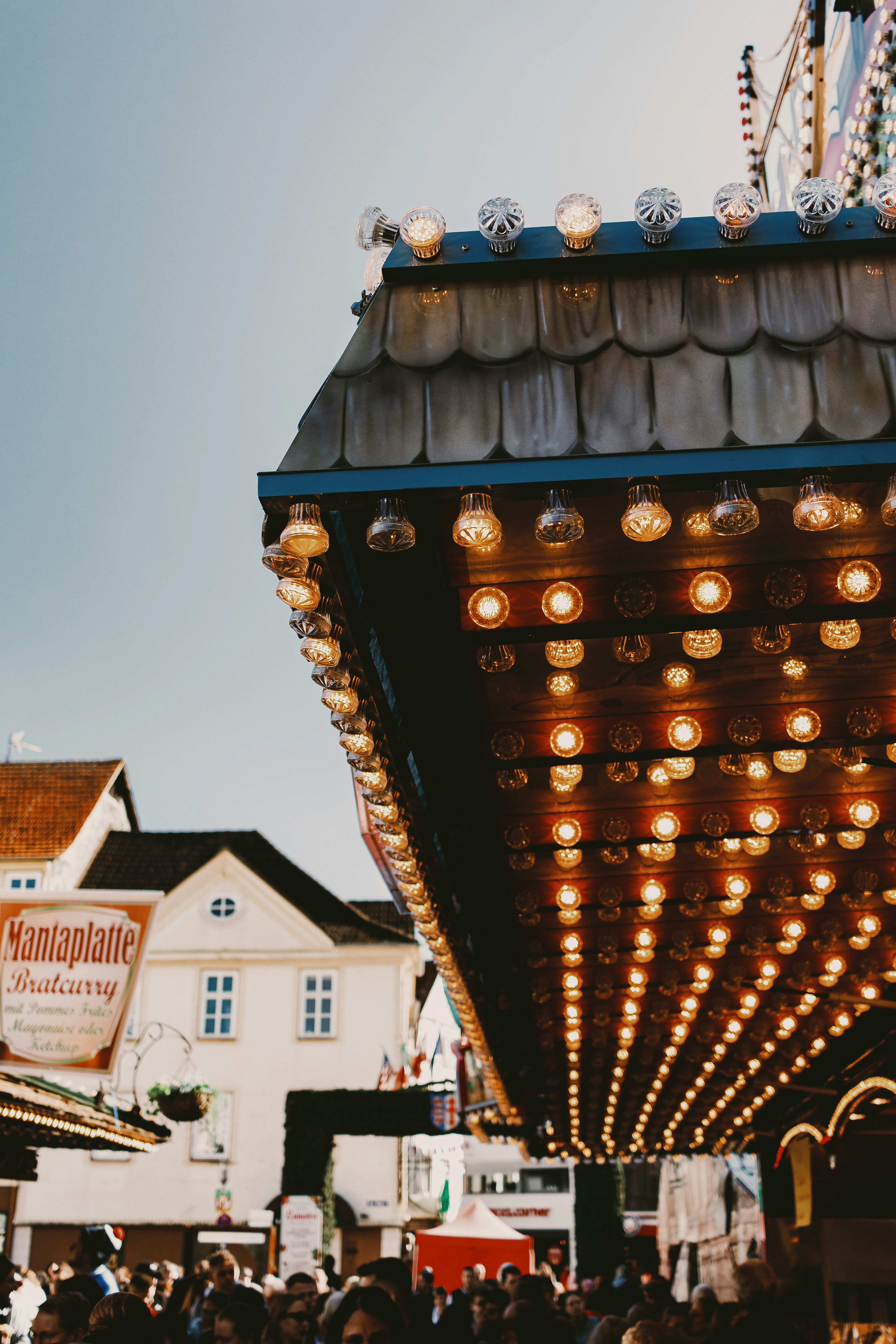 Bulb-bathed Carnival Canopy Over a Bustling Village Fair