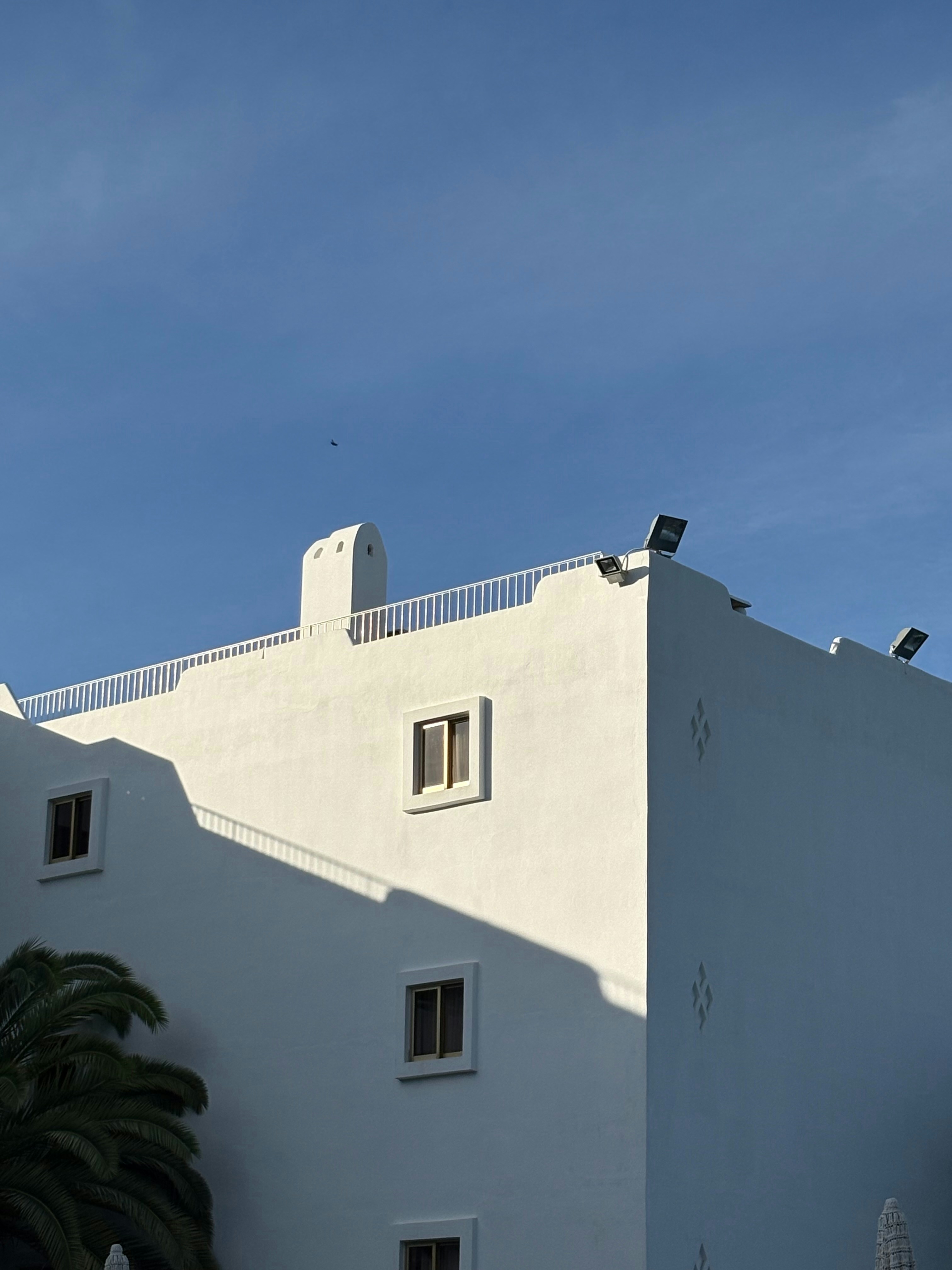 White building with windows against a blue sky