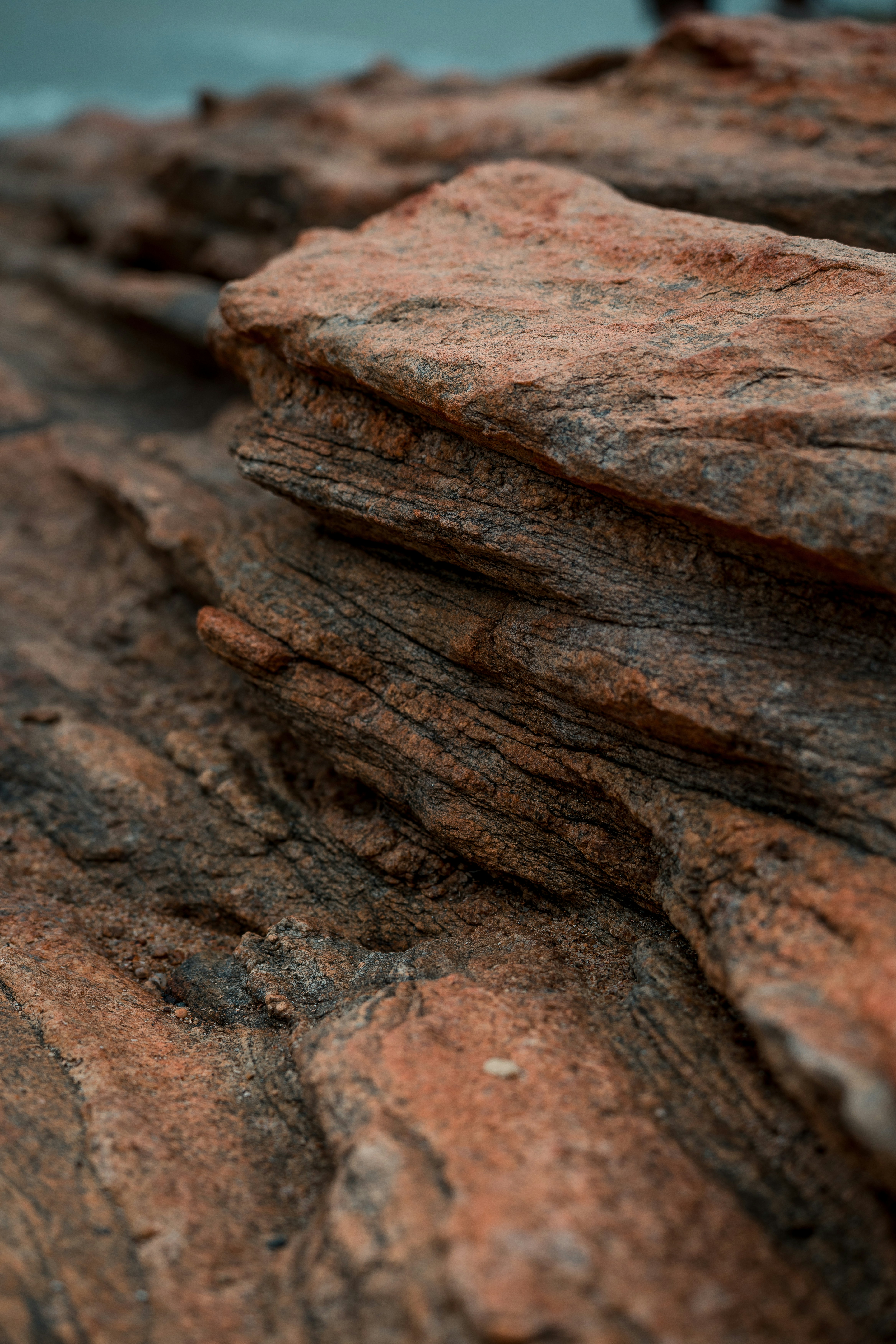 Close-up of layered, textured reddish-brown rocks.