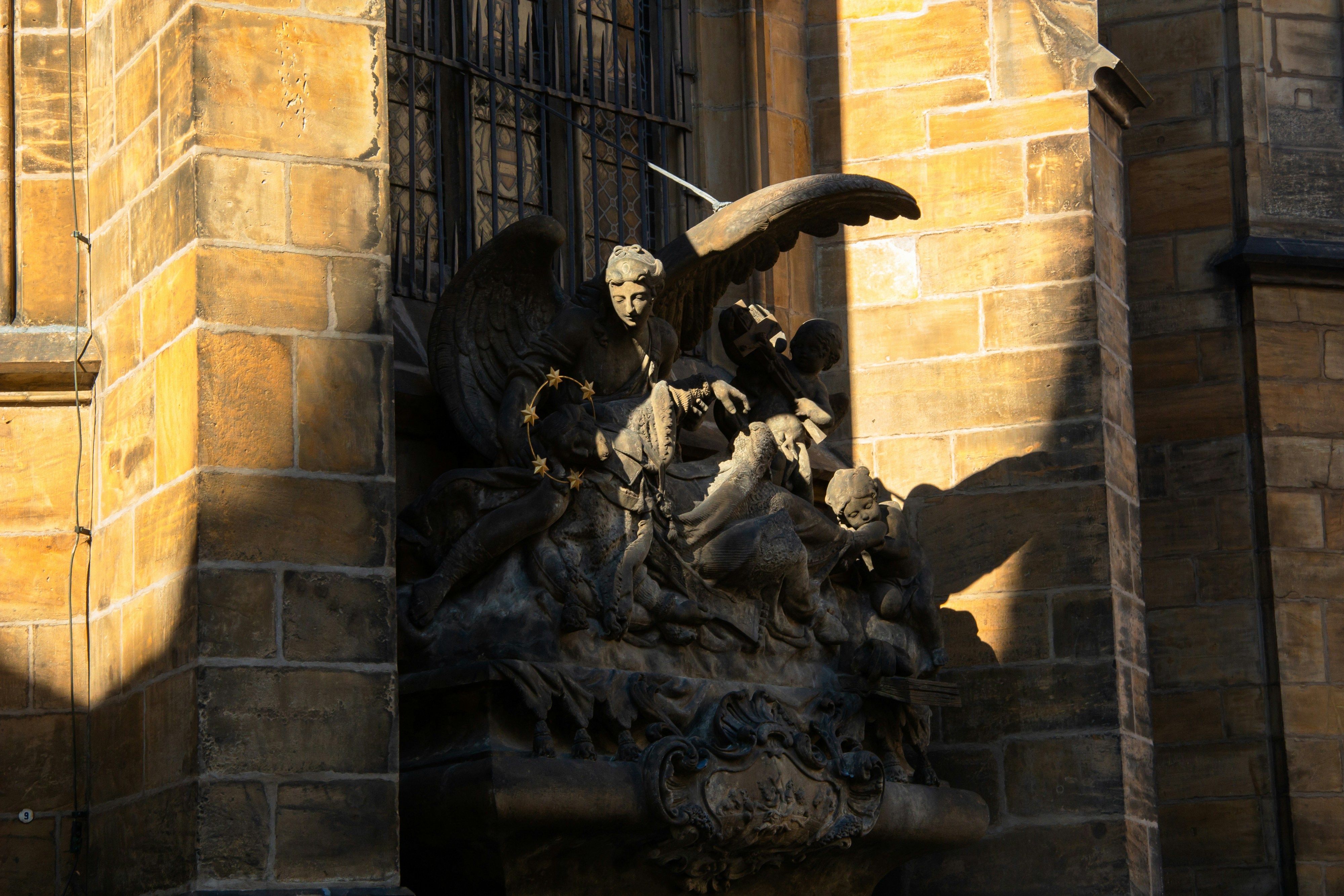 Stone sculpture of a winged figure on building facade. photo – Free ...