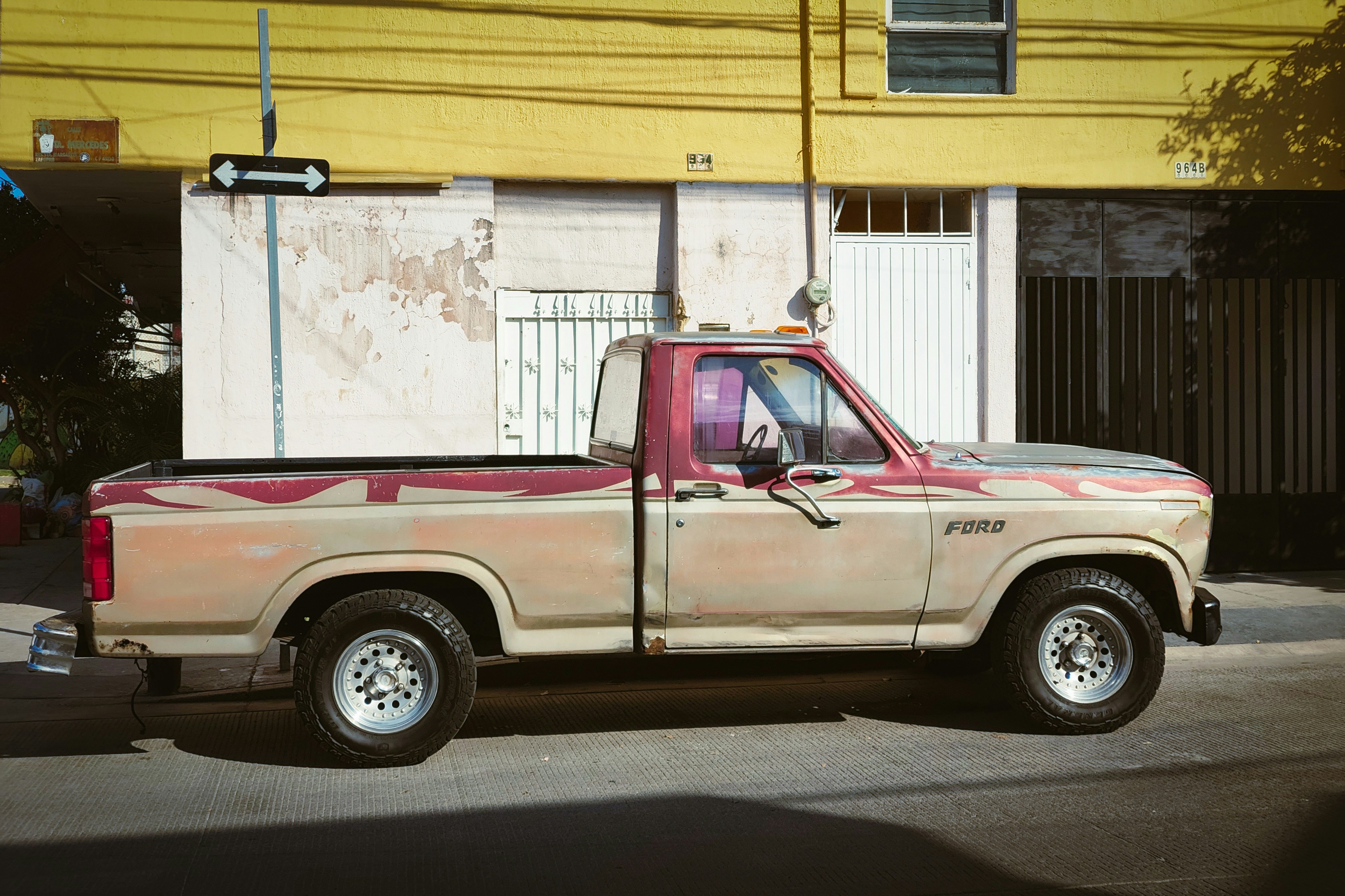 A vintage pickup truck parked on a street.