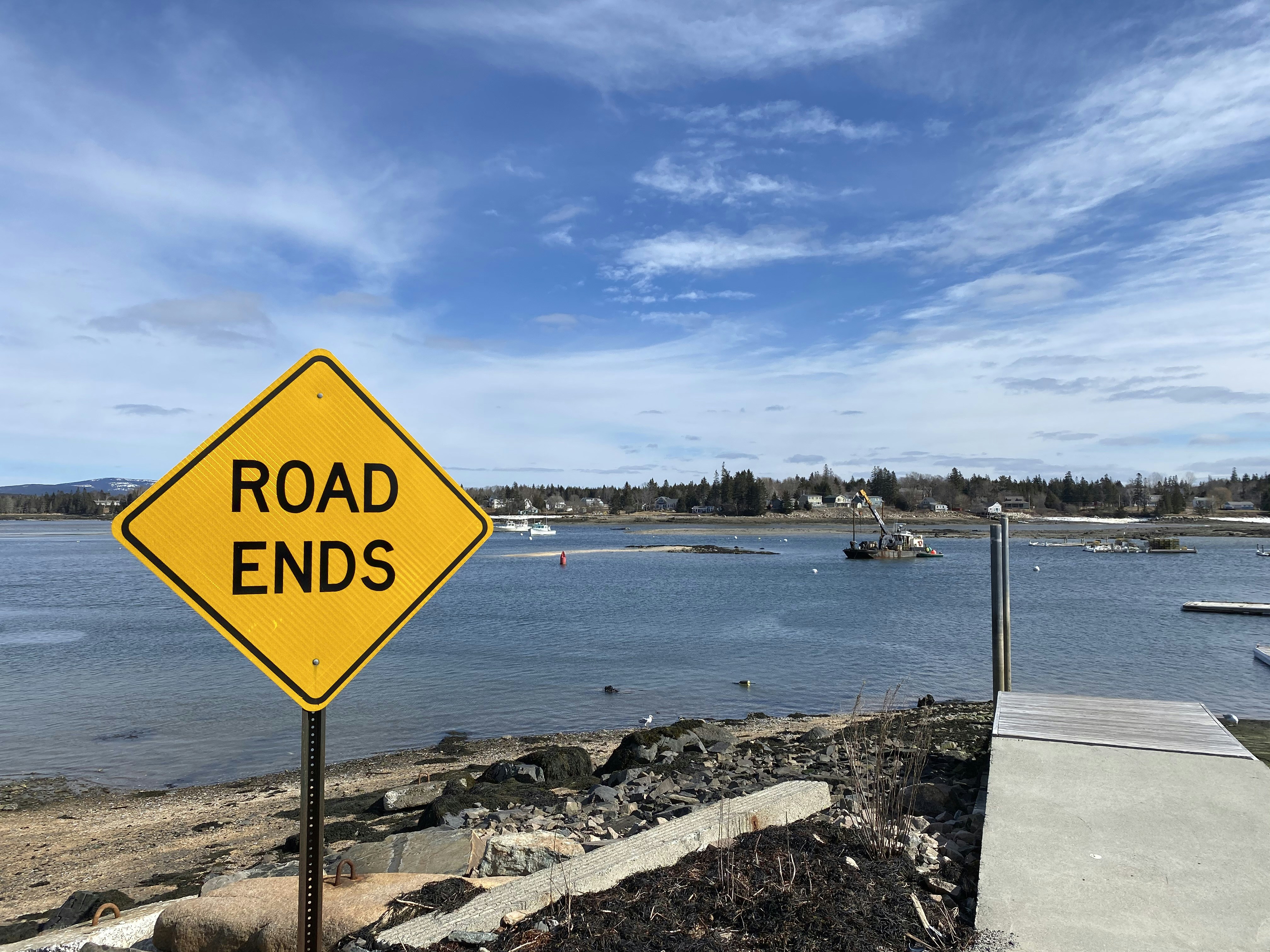 Road Ends on a short trip to nowhere. End of the line. That's it. Final stop... Perfect clip art as part of the Hidden in Plain Sight series — exploring how design, language, and symbols say more than they mean. Each image functions as a relational ontology fragment: a vessel for meaning transfer across time, context, and interpretation. | Yellow road ends sign by the water