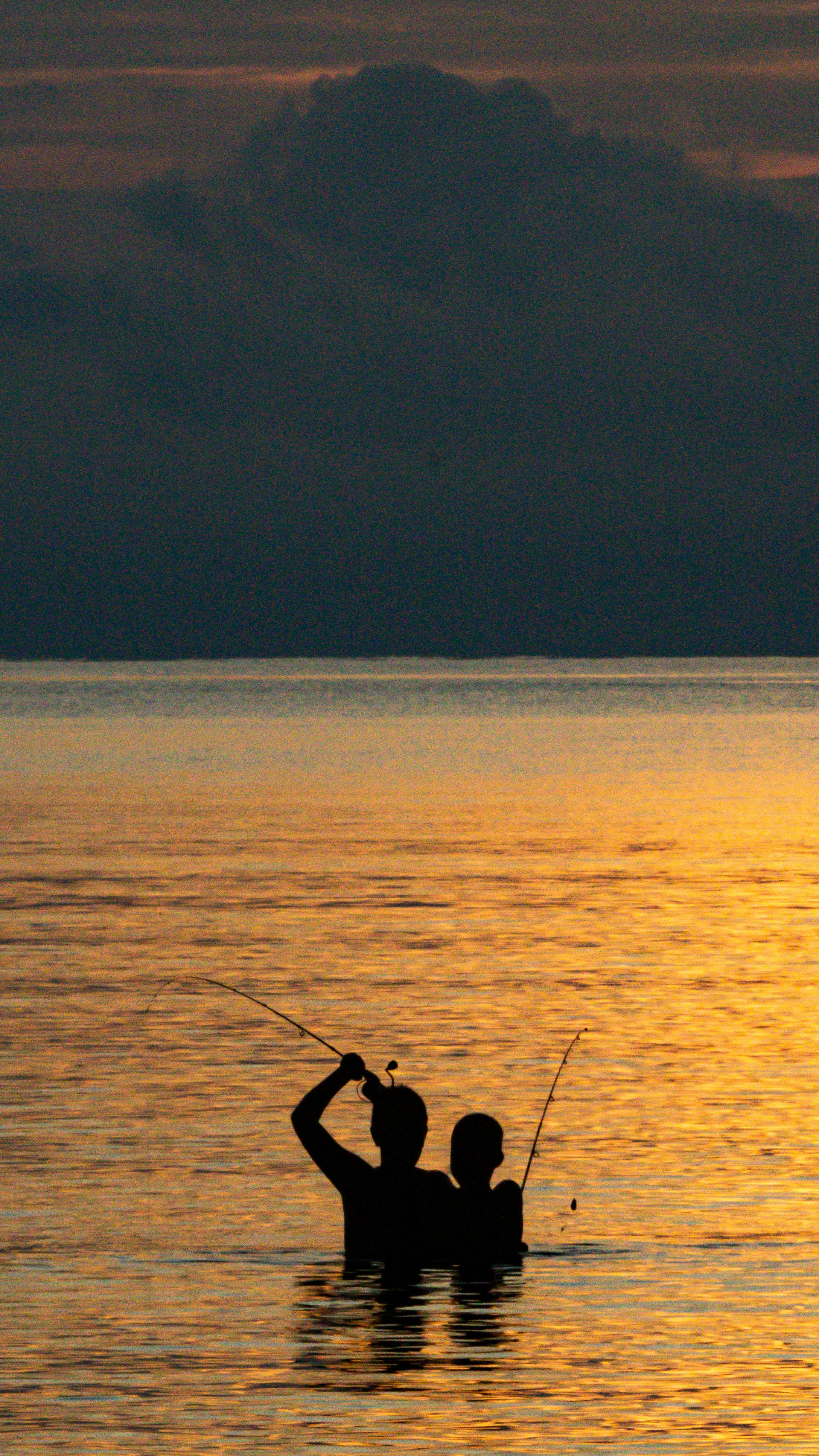 Harmony at Dusk: A Fisherman's Bond