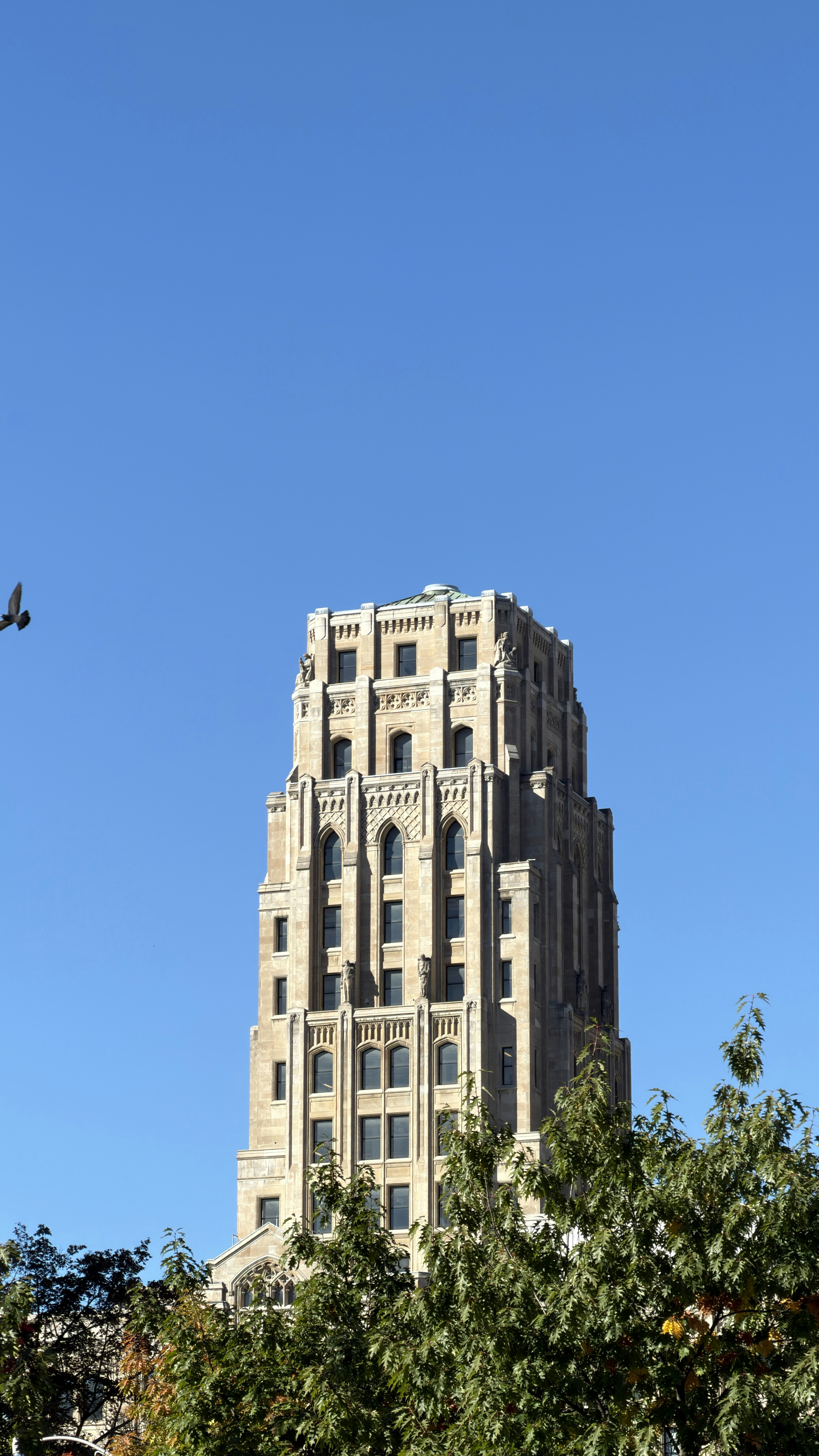 Neo-Gothic Tower Reaches Sky in Clear Blue Backdrop