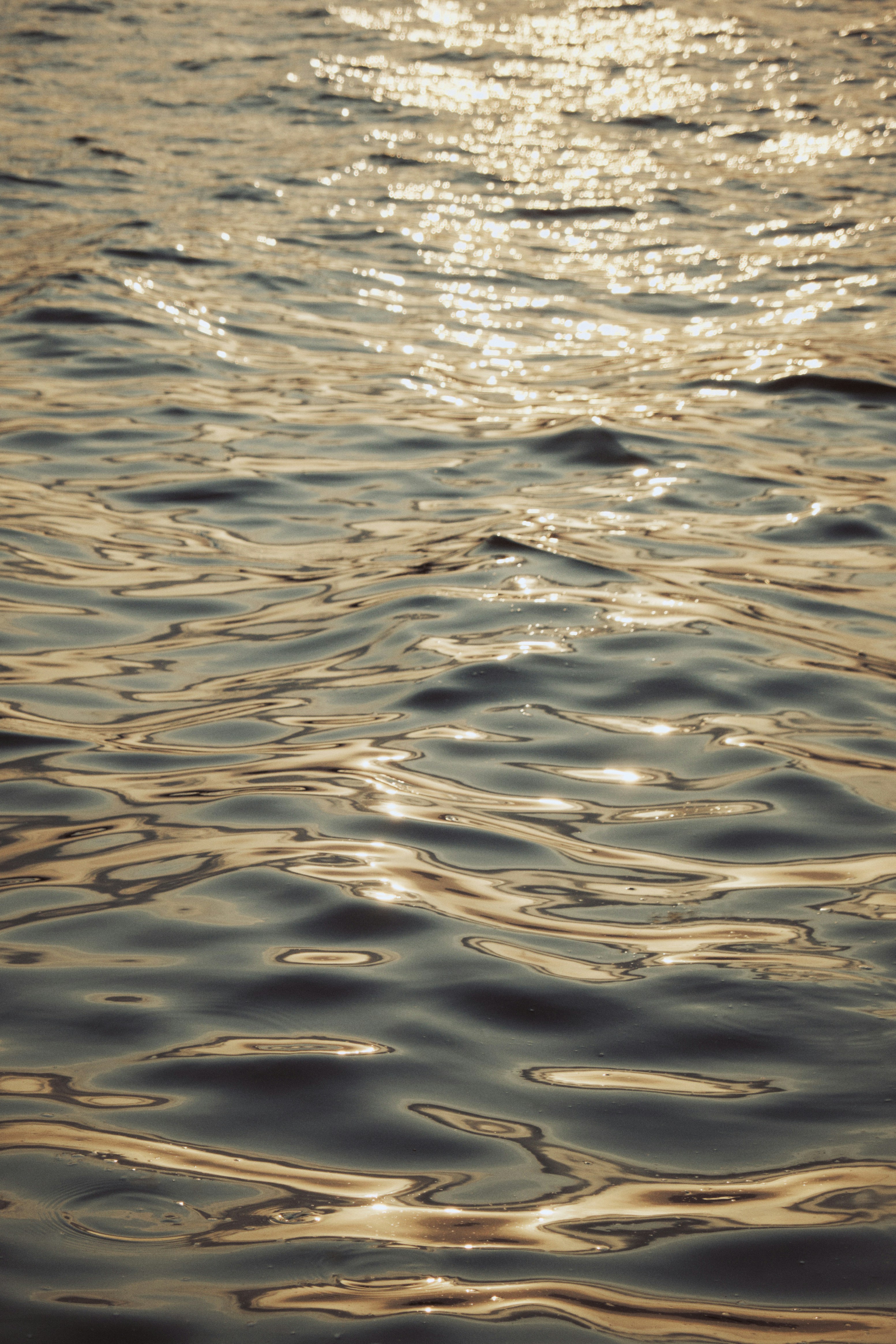 Sunlight glinting on rippling water surface