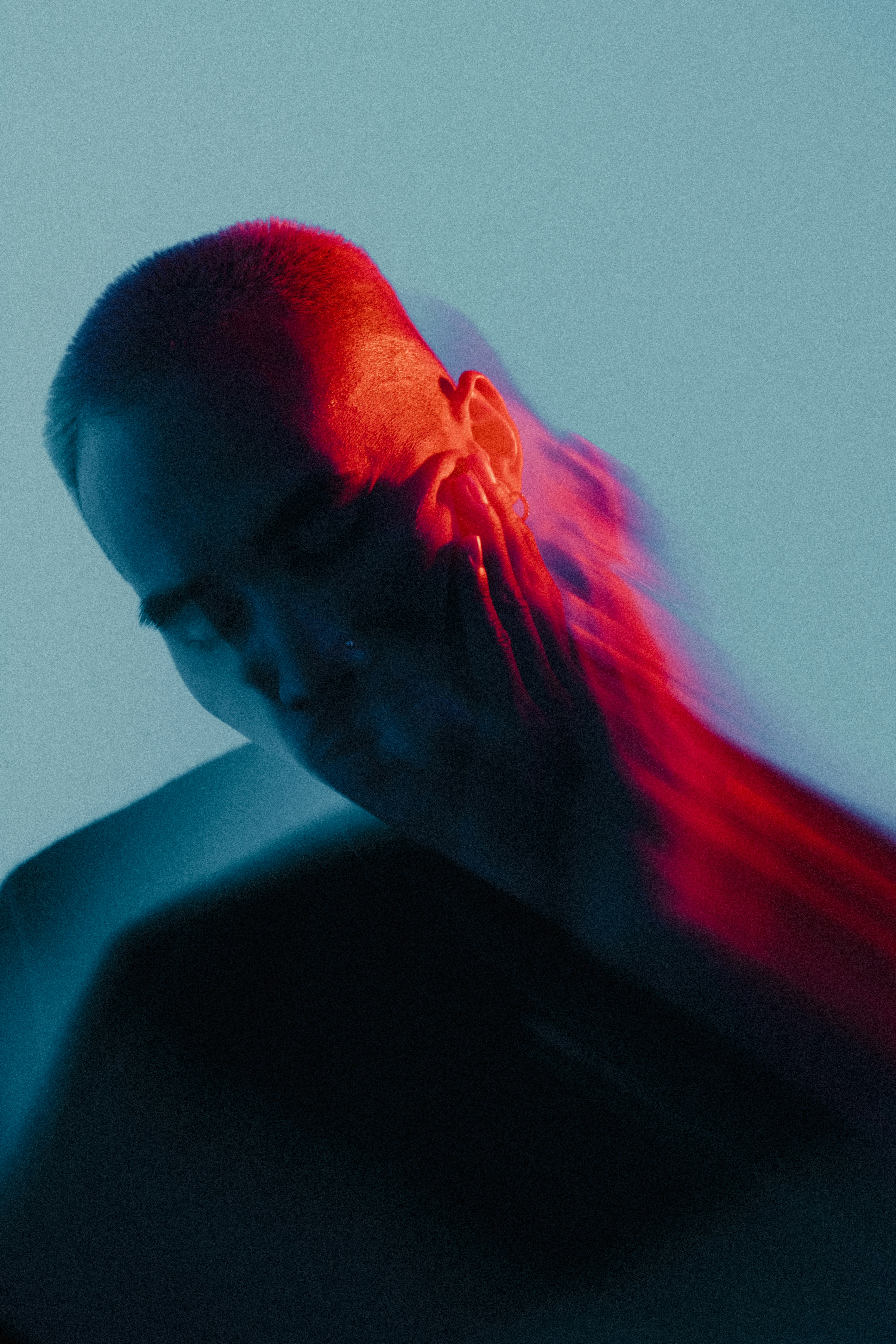 Neon Tilt: Blue hush and crimson edge on a portrait