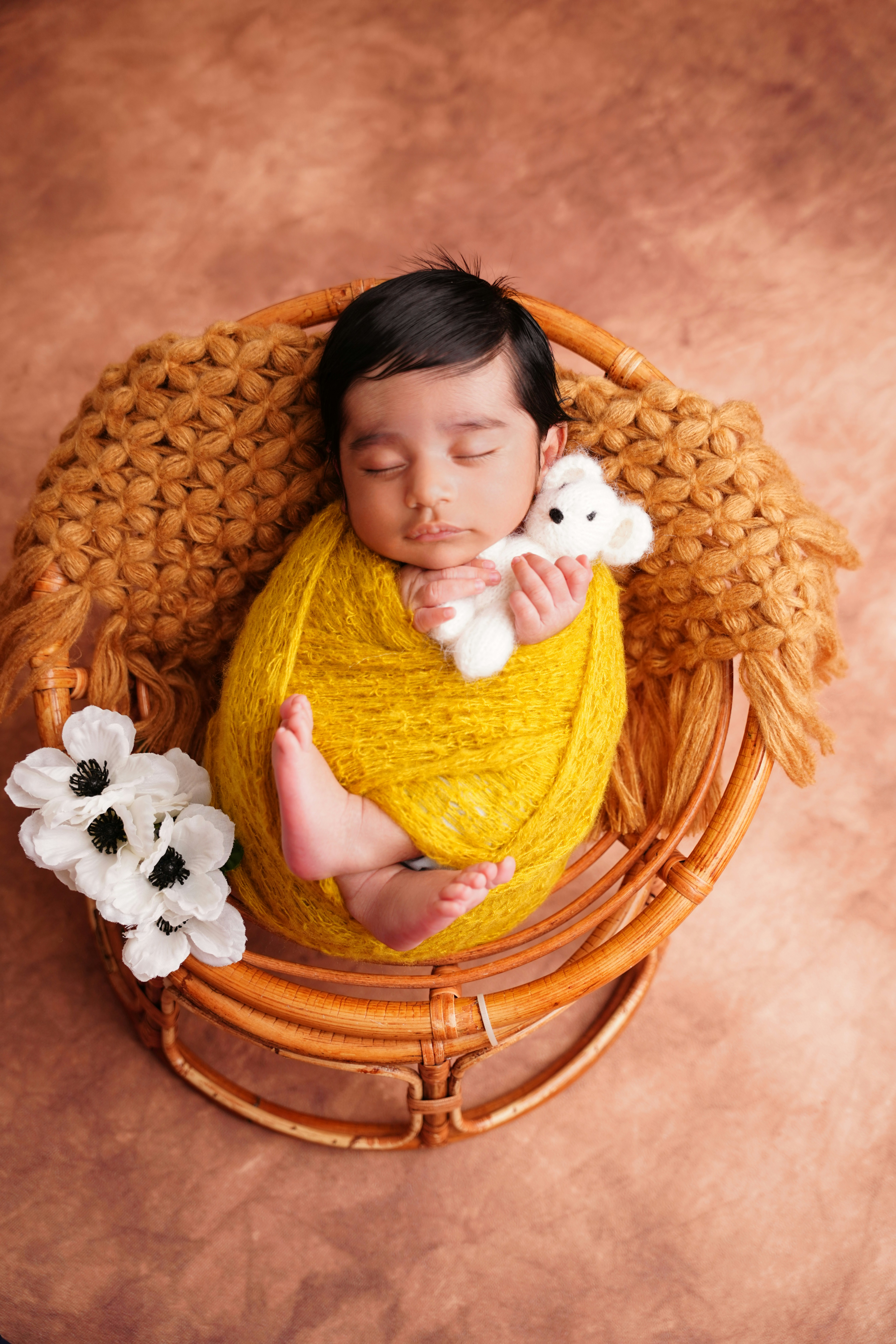 Newborn baby sleeping with a stuffed toy