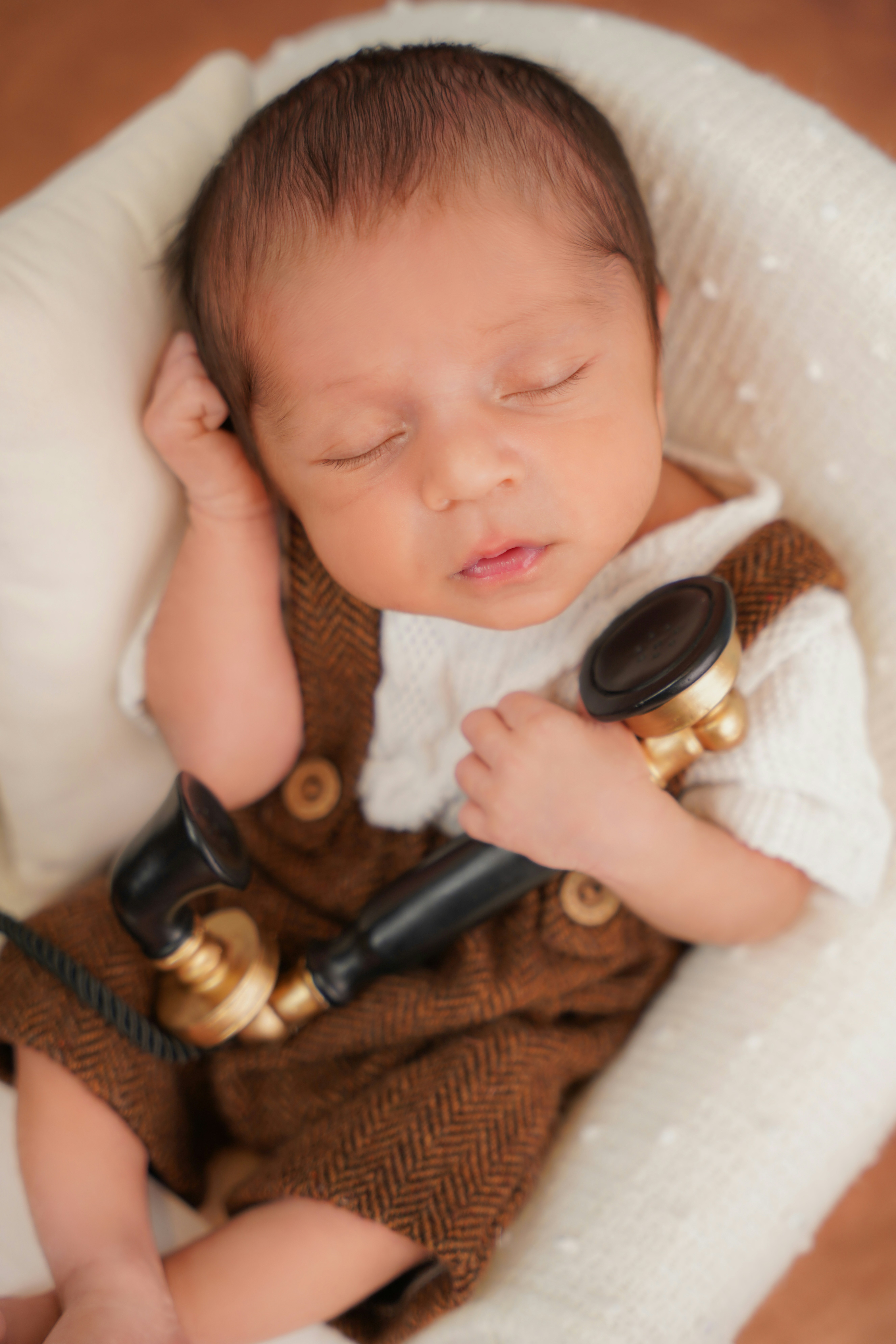 Lullaby in a Brass-Hued Embrace: Sleepy newborn with vintage telephone